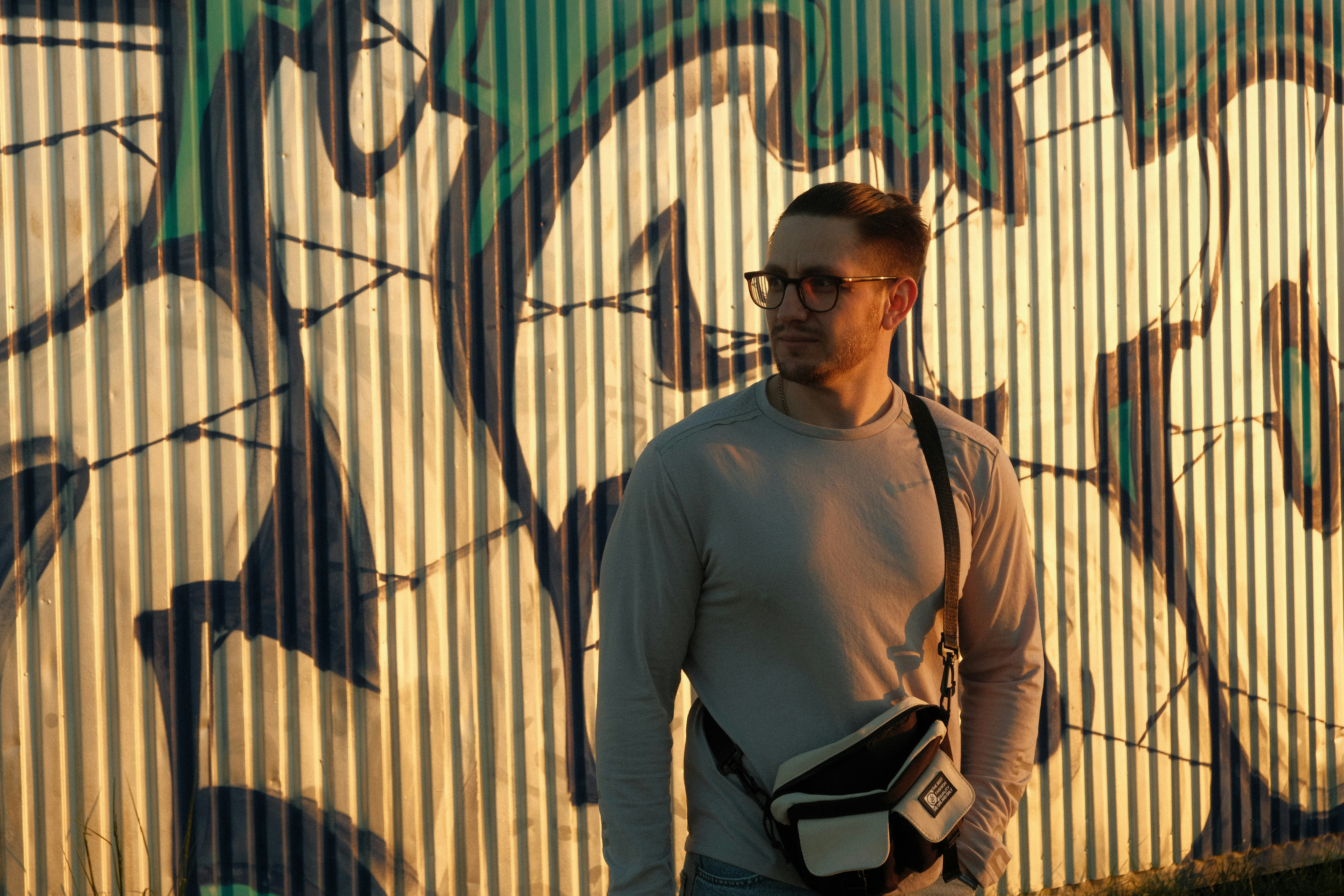 Sunlit Echoes: Portrait Before a Graffiti-Wall Corrugated Backdrop