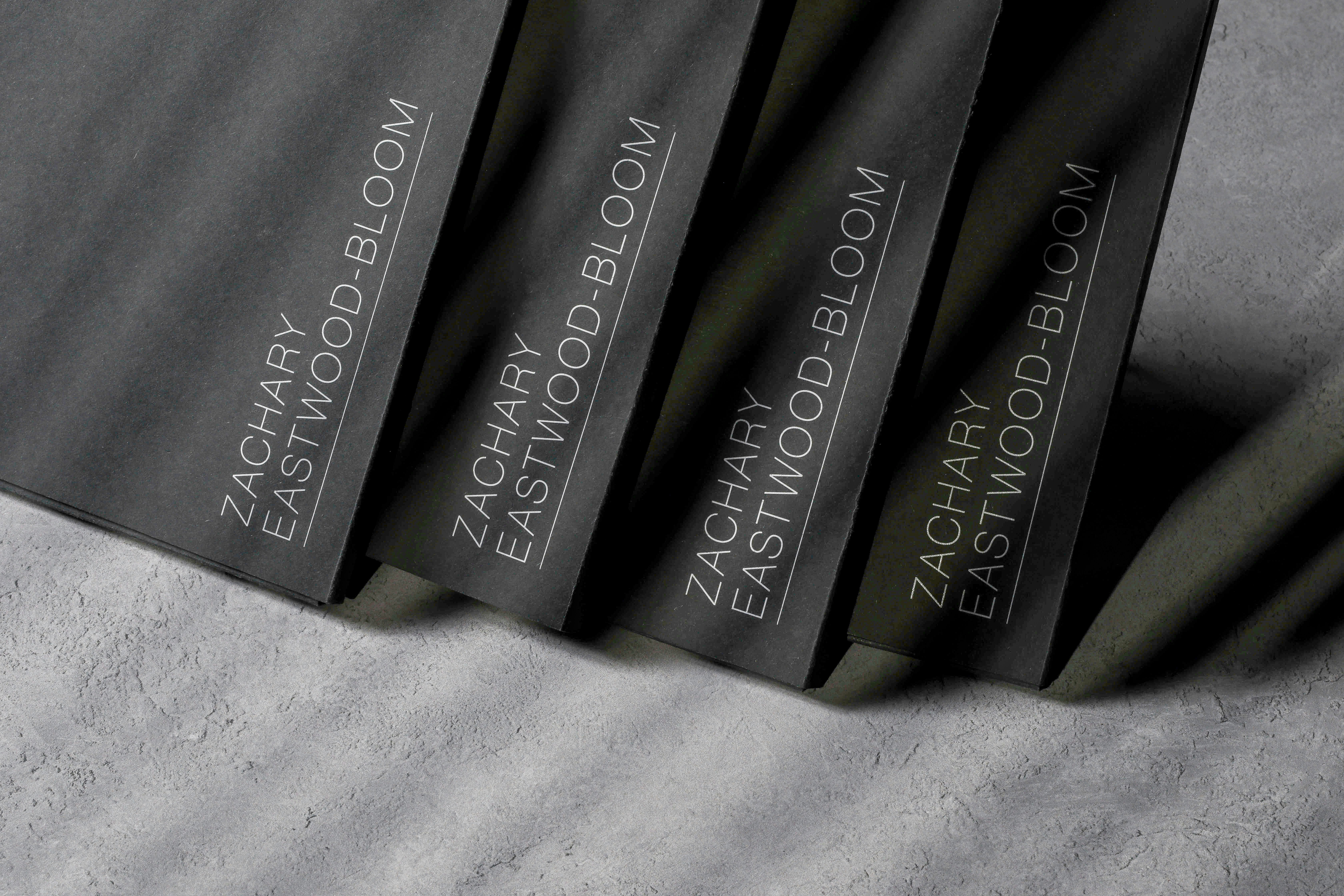 Stacked monochrome spines: a close-up study of branded edges on a textured surface