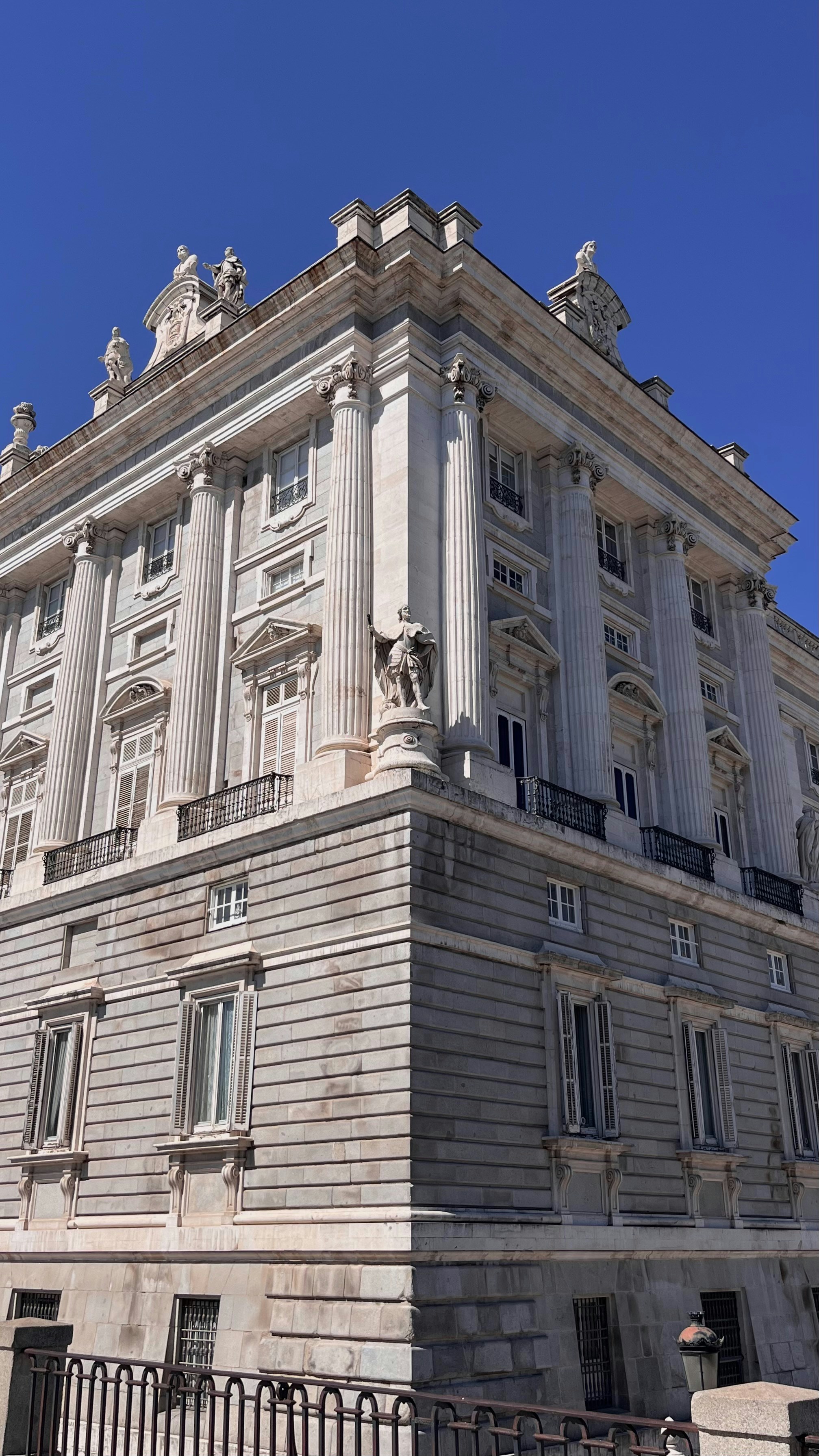 Cornerstone on Blue: Neoclassical Facade Reaching Toward the Sky