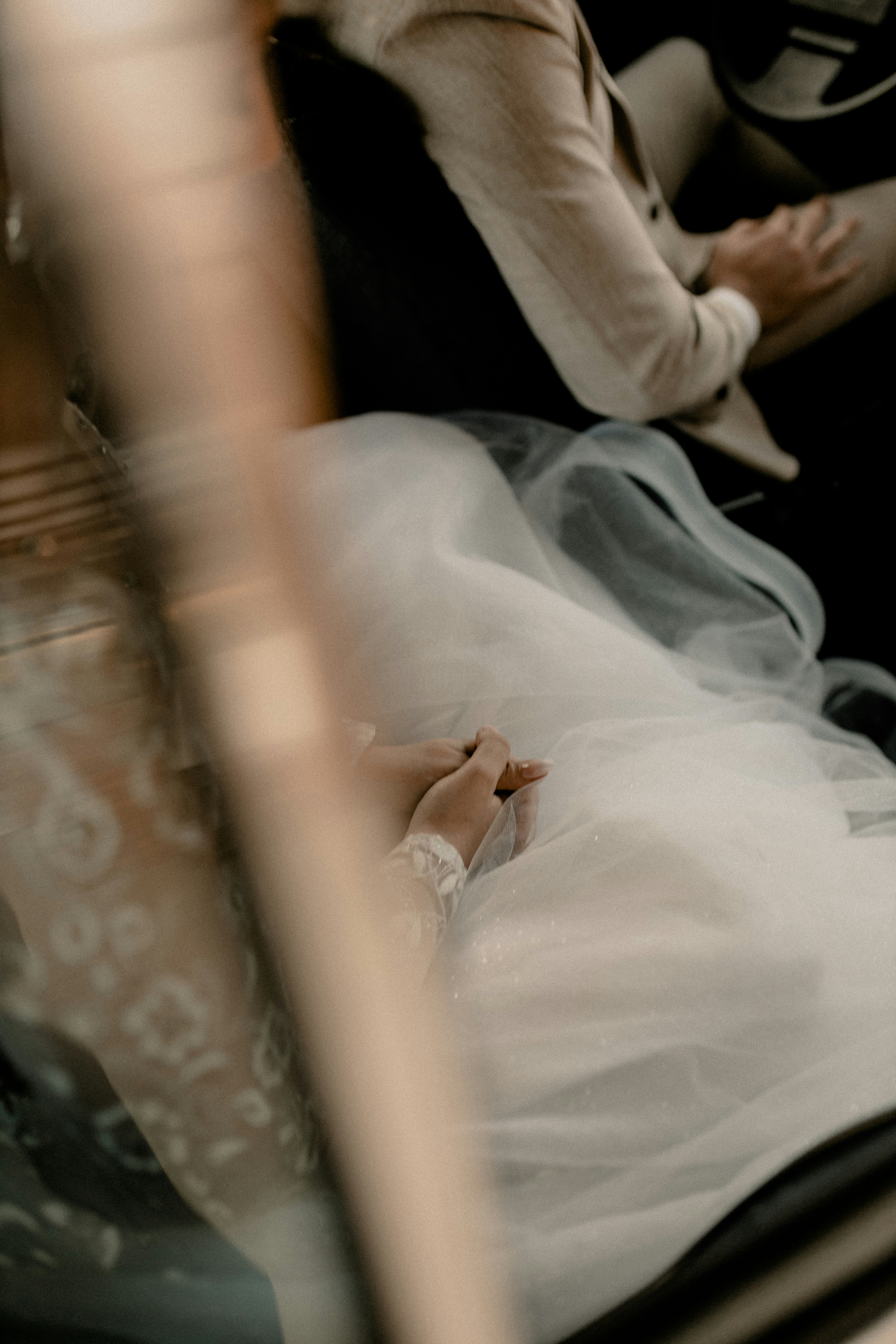 Intertwined Promises: A Quiet Moment in White Tulle