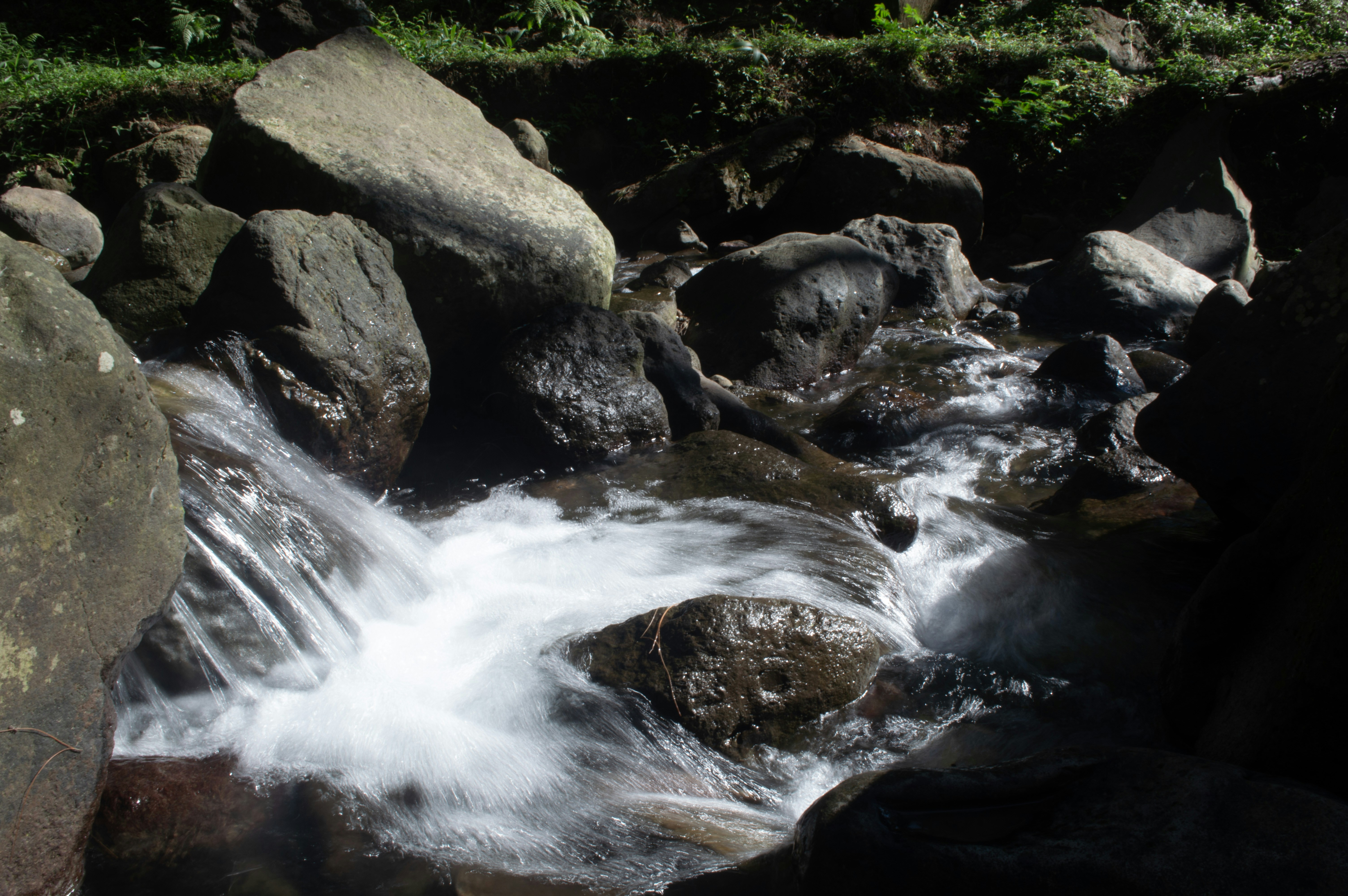 A small stream of water running between rocks