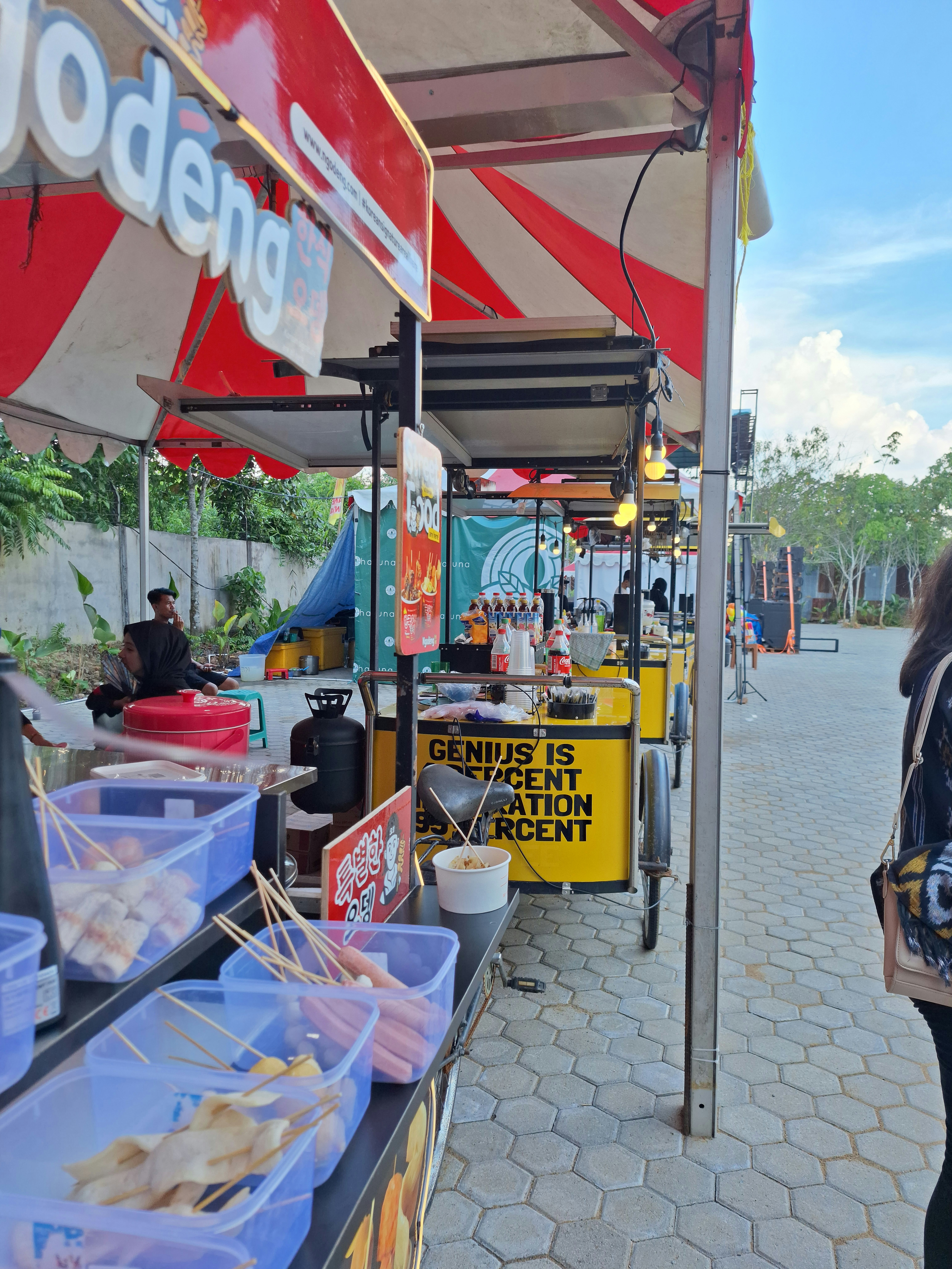 A woman standing in front of a food stand