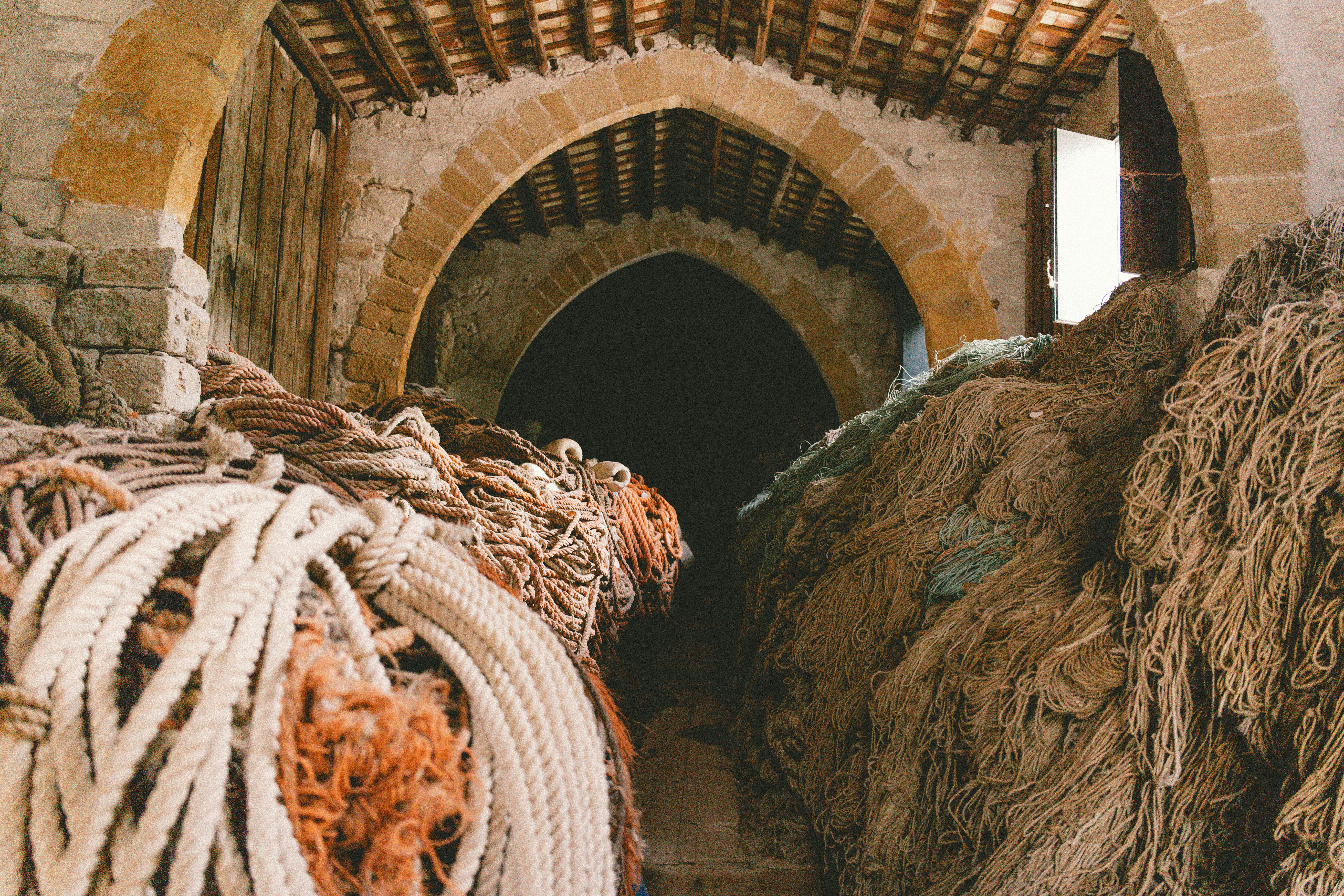 A tunnel in a stone building with rope wrapped around it