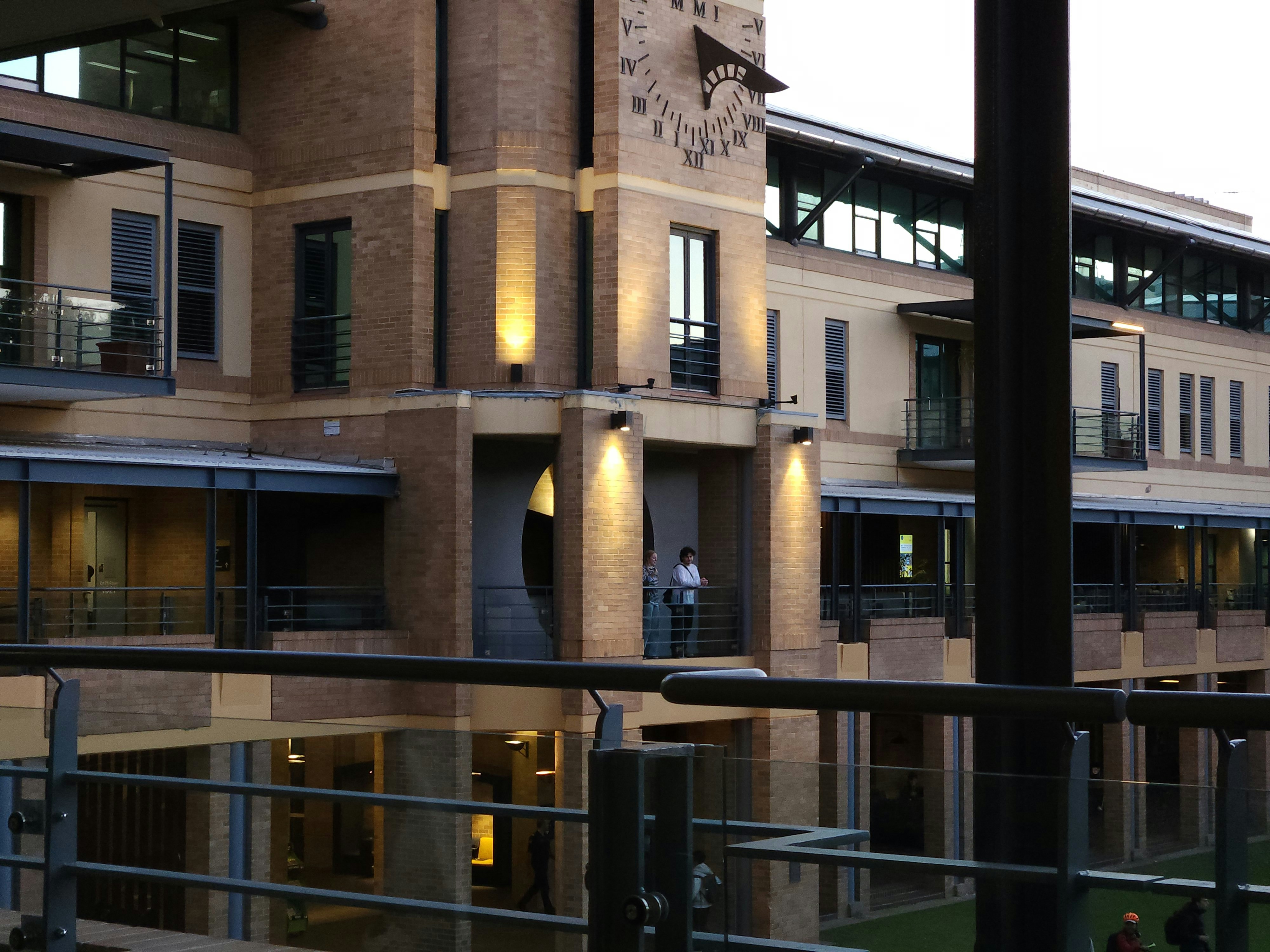 A tall building with a clock on the side of it photo – Free Unsw sydney ...