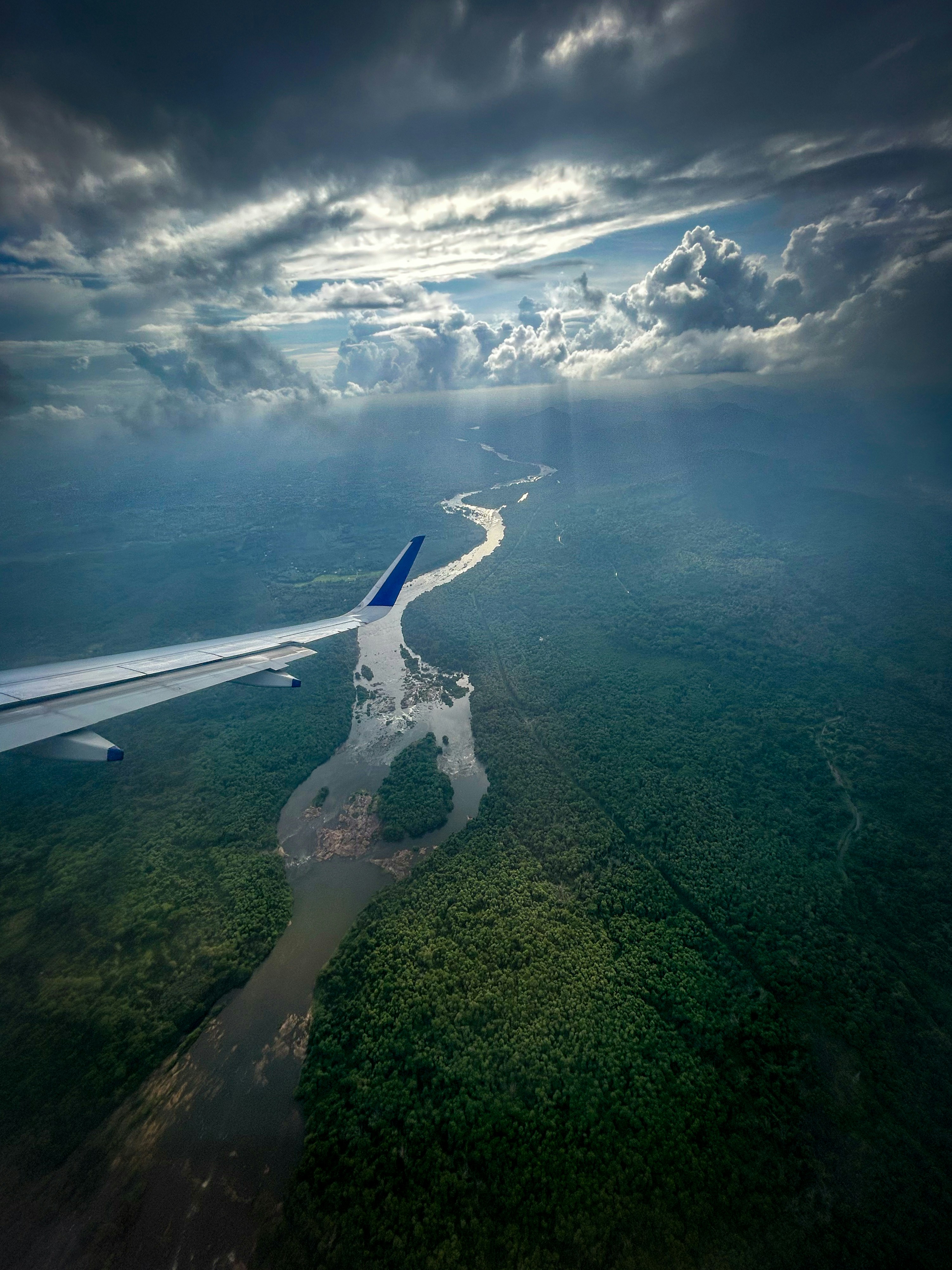 Wing over the Meandering River: Aerial Forestscape from Cloud-Scale View