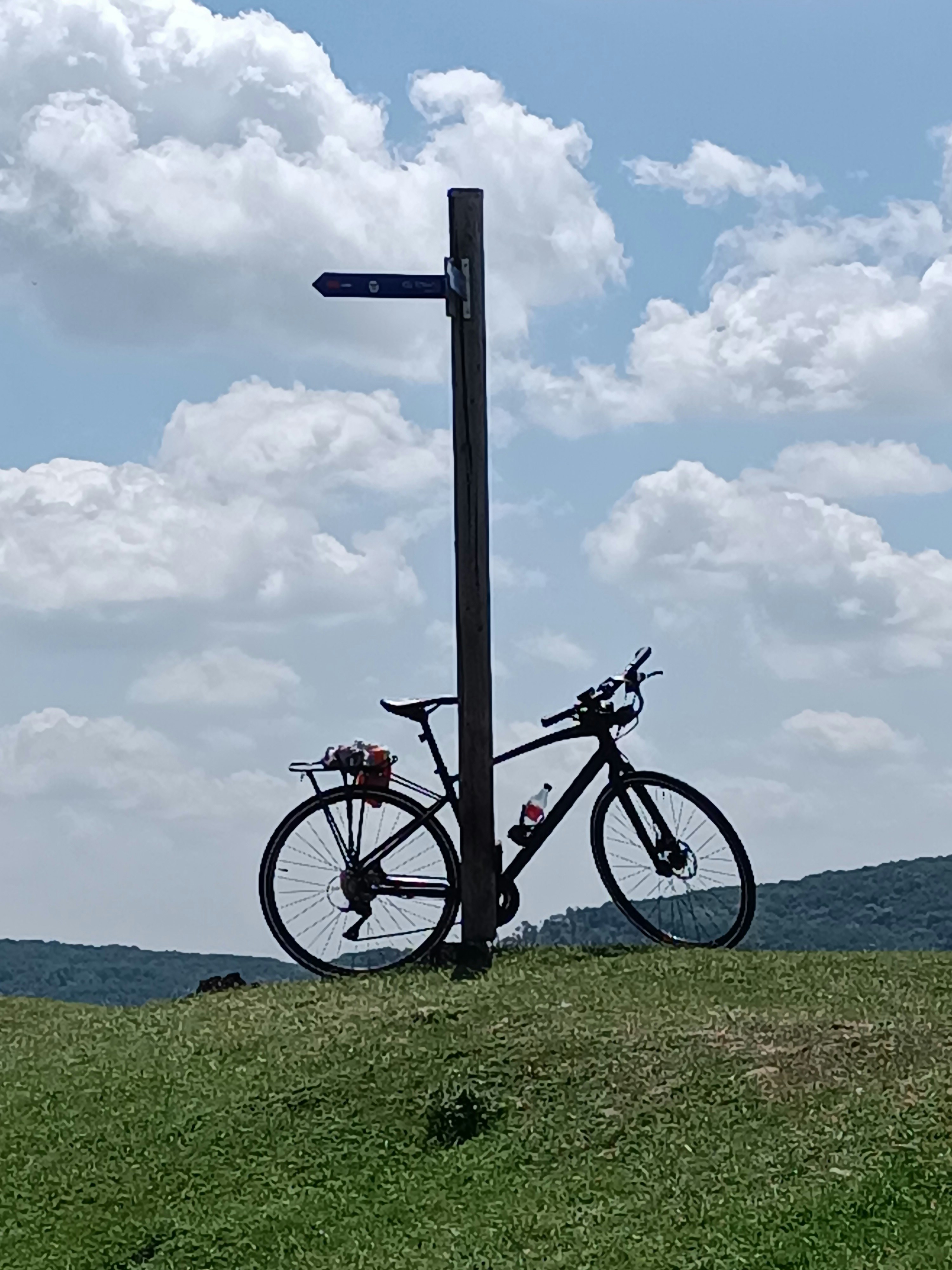 Bike Resting Against a Signpost at a Hilltop Vista