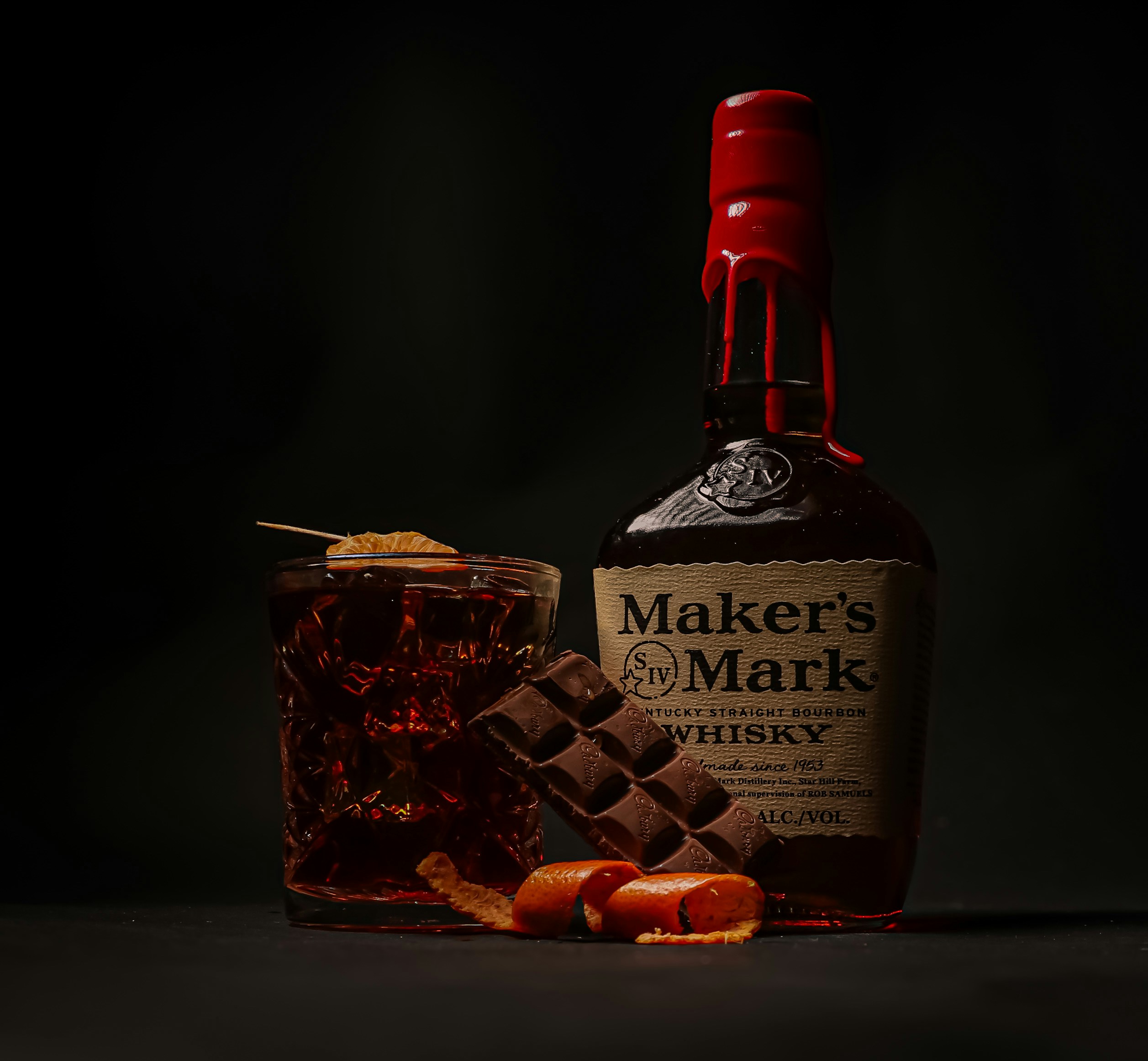 A bottle of maker's mark whiskey next to a chocolate bar photo – Free ...