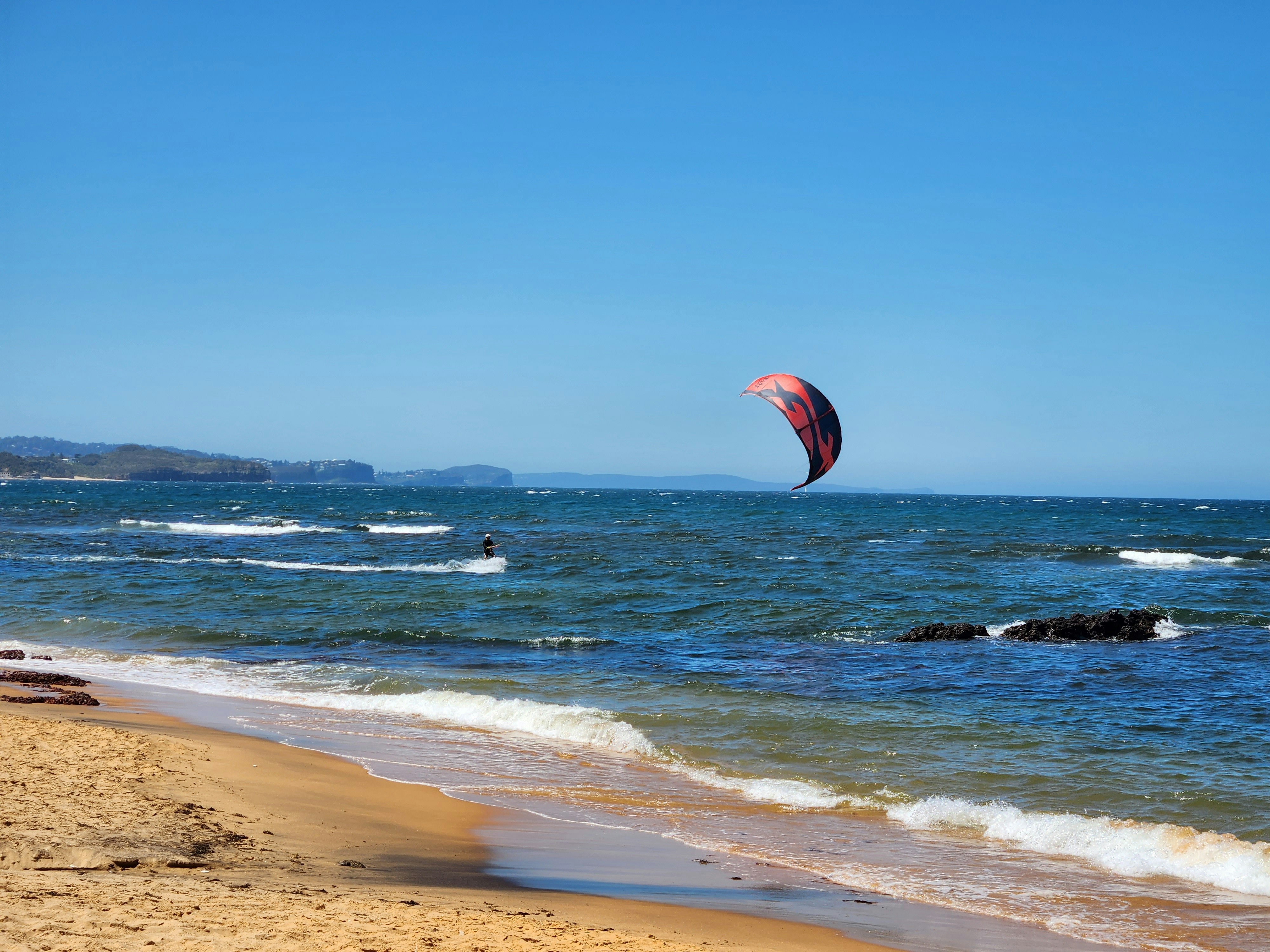 A person para sailing on the ocean on a sunny day