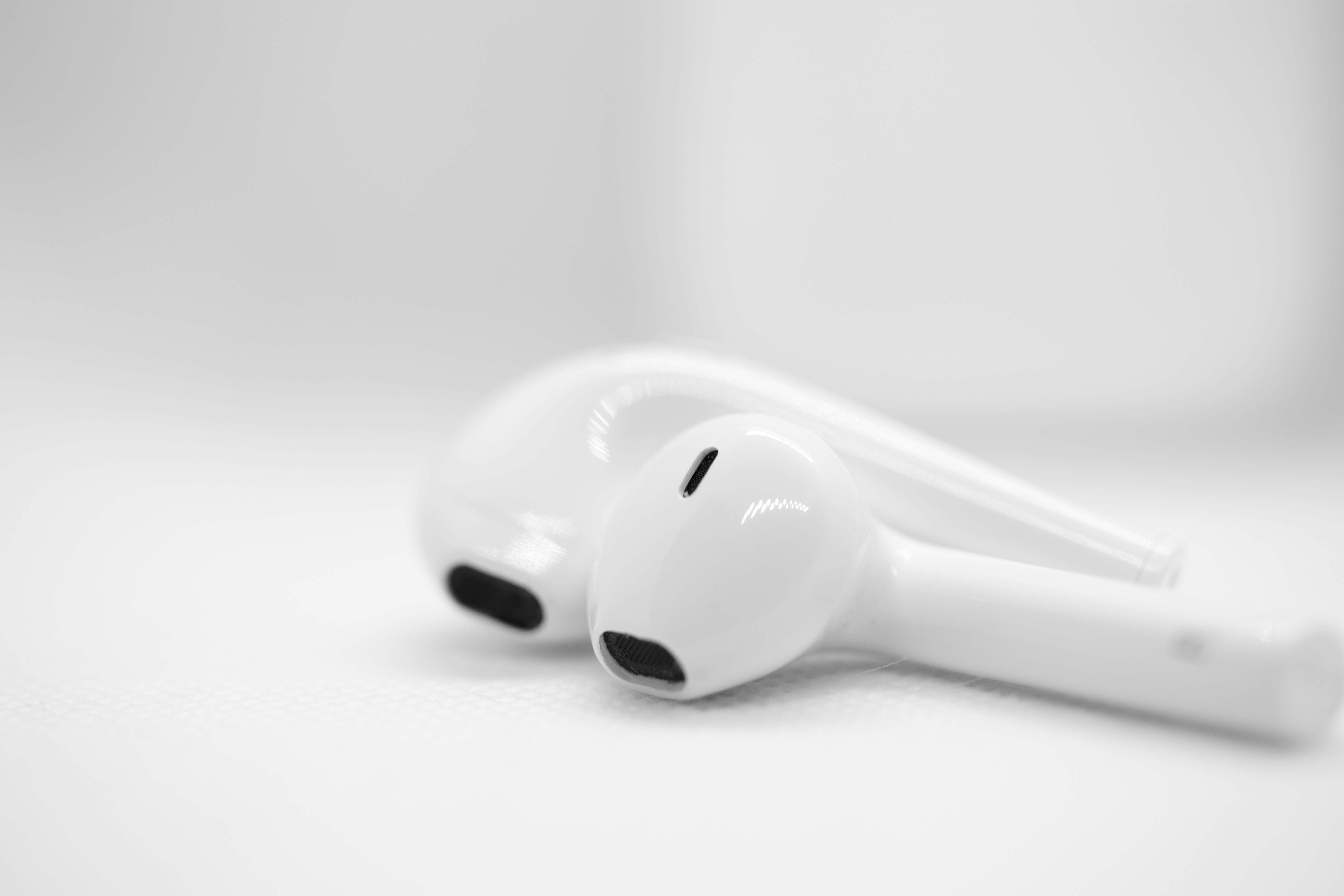 A pair of ear buds sitting on top of a table photo – Free Grey Image on ...