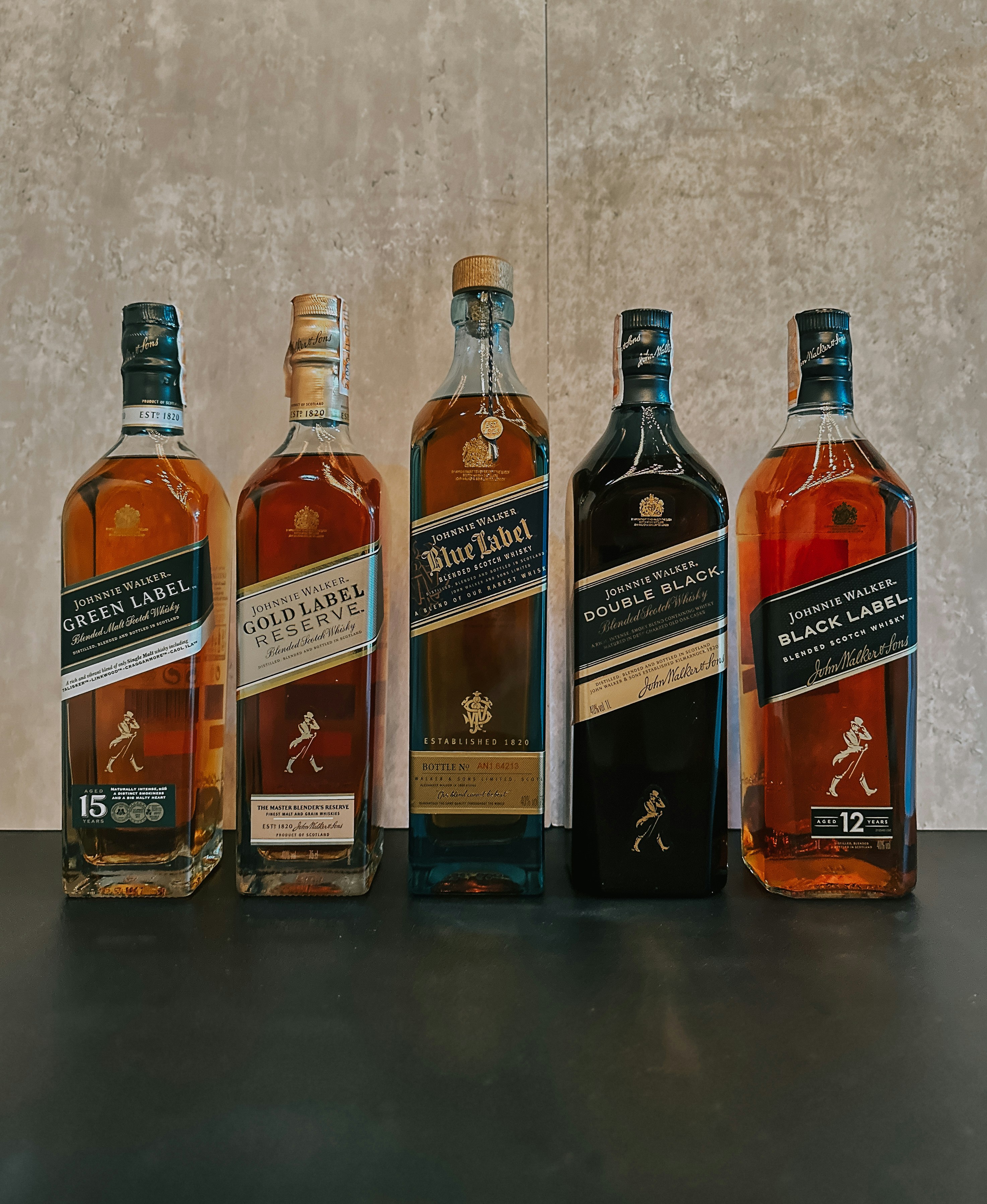 A row of bottles of different types of alcohol photo – Free Night Image ...