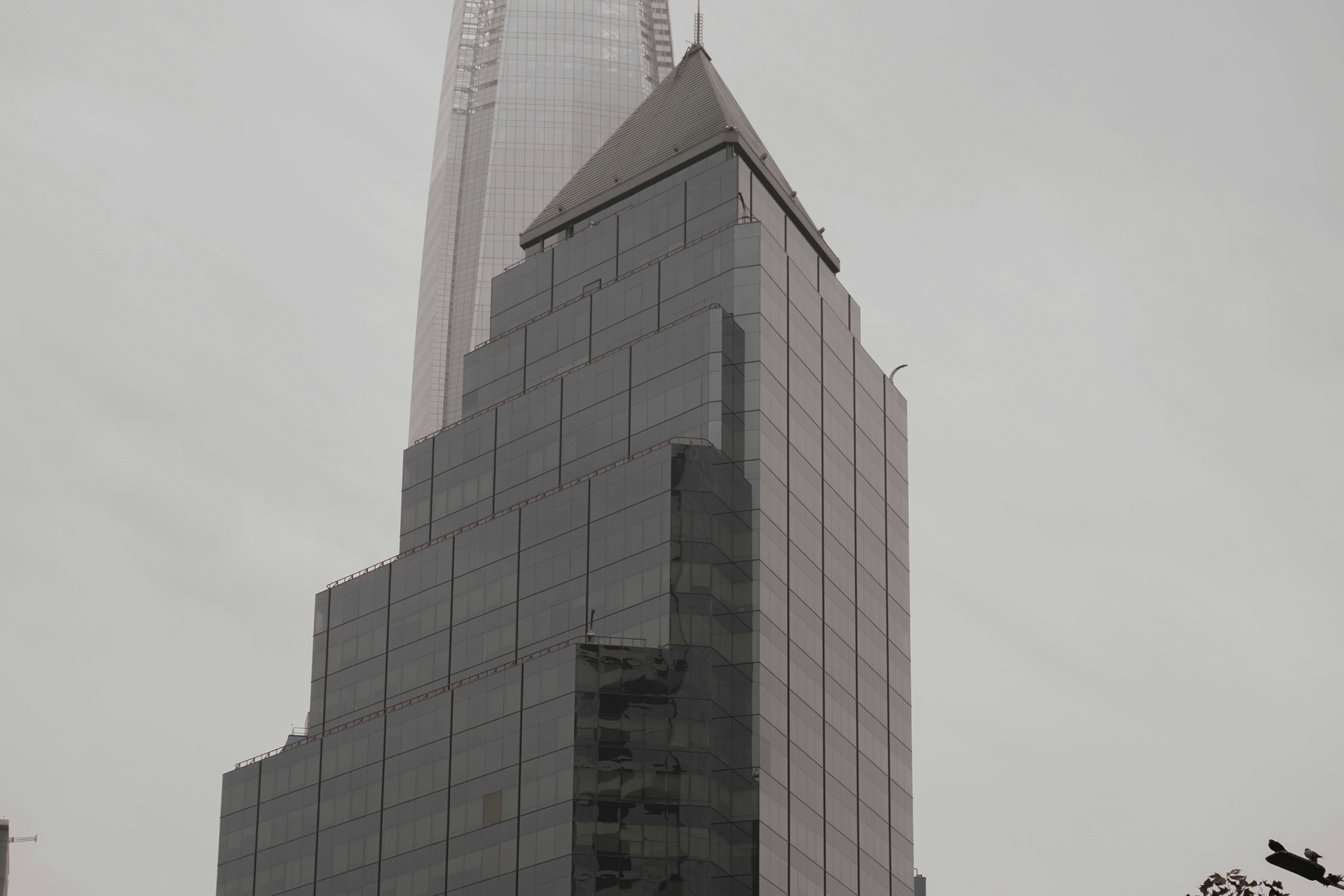 Monolithic Crown: A Step-Back Glass Tower Rises in Pale Light