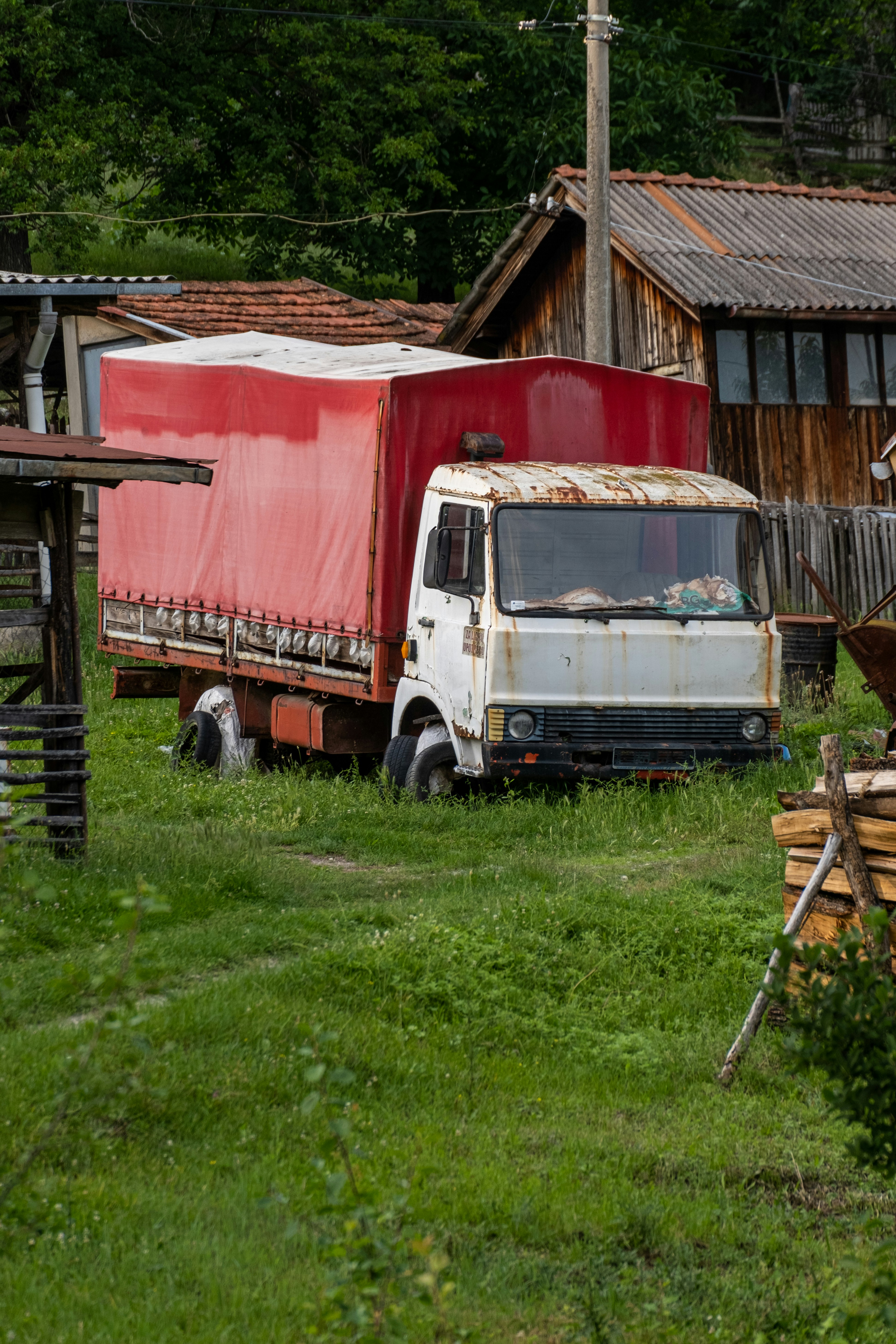 Red Canvas Haul Truck in a Quiet Rural Yard
