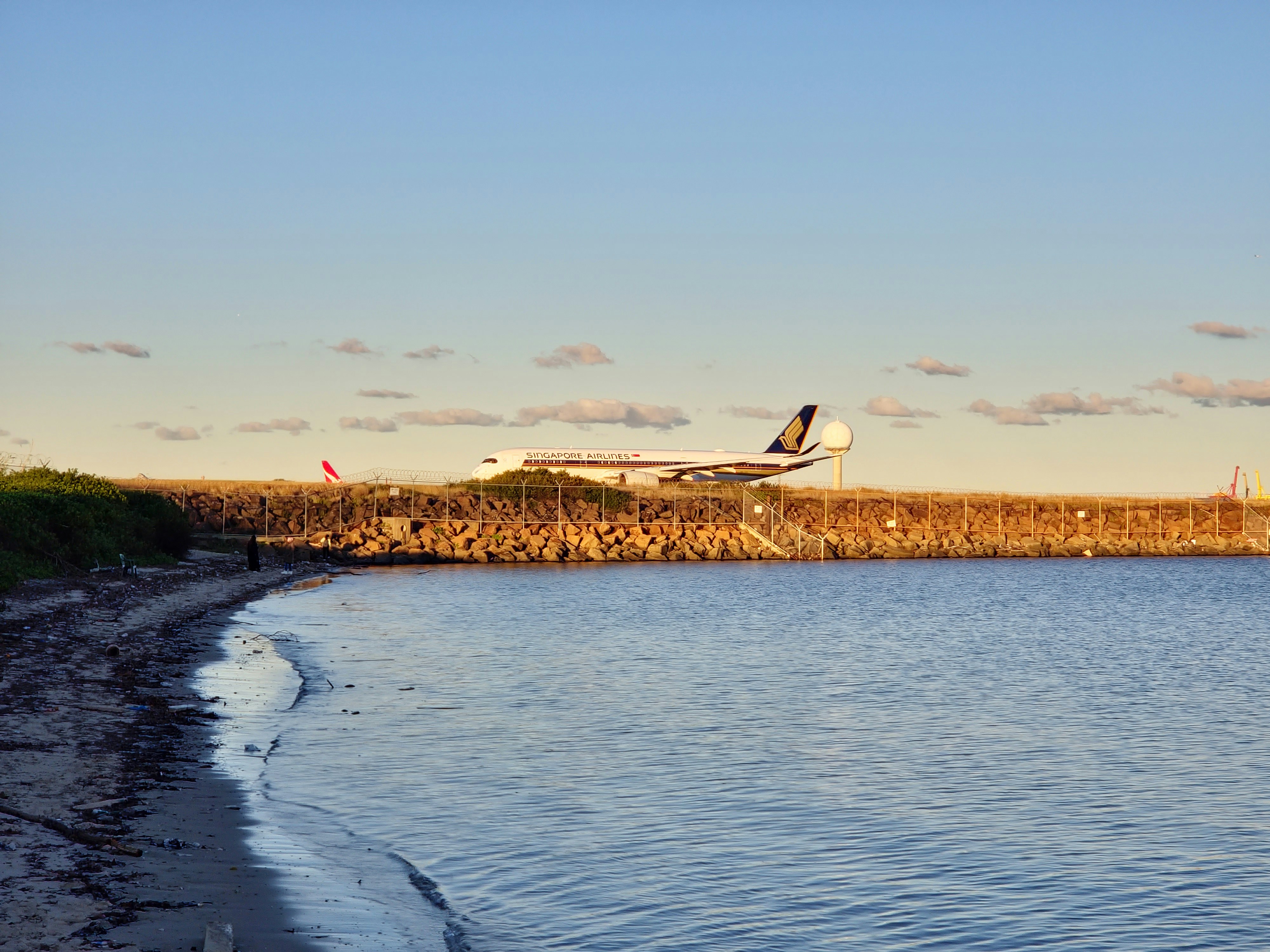 Sunset Seaplane Resting Along a Calm Breakwater