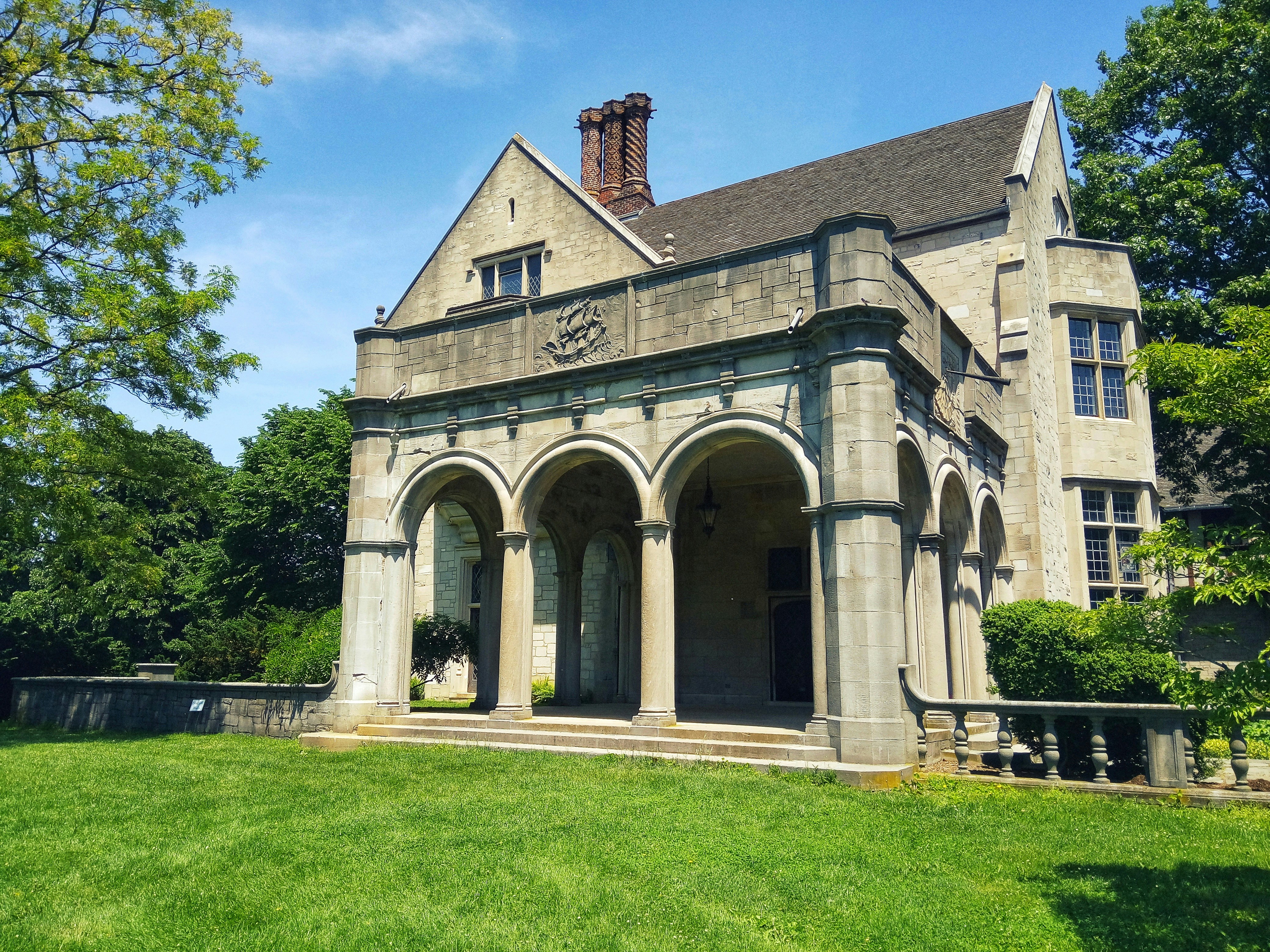 A large stone building with a clock tower photo – Free Coe hall ...
