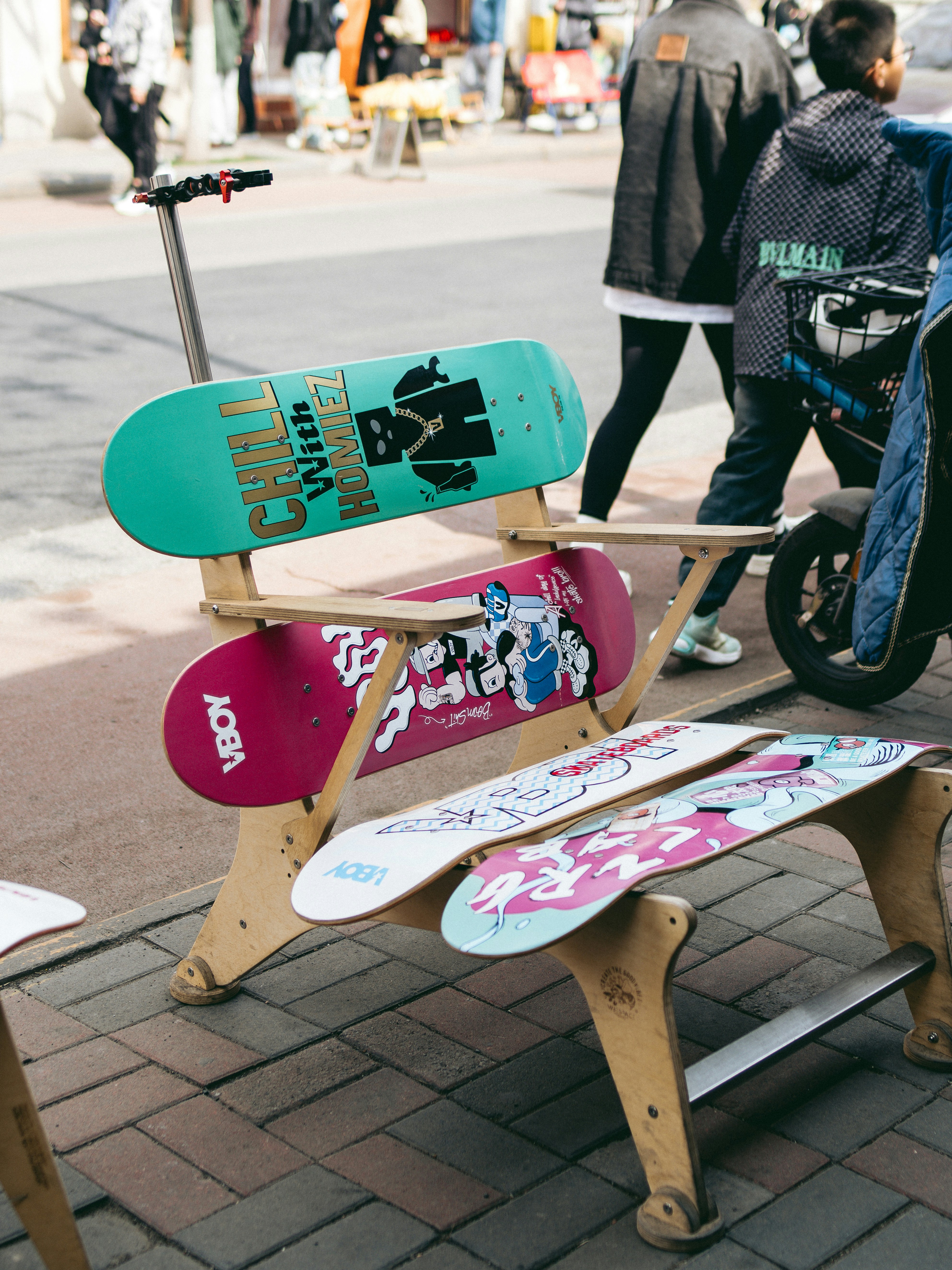 Turquoise Deck Crowns a Pink: A Street Bench of Colorful Skateboards