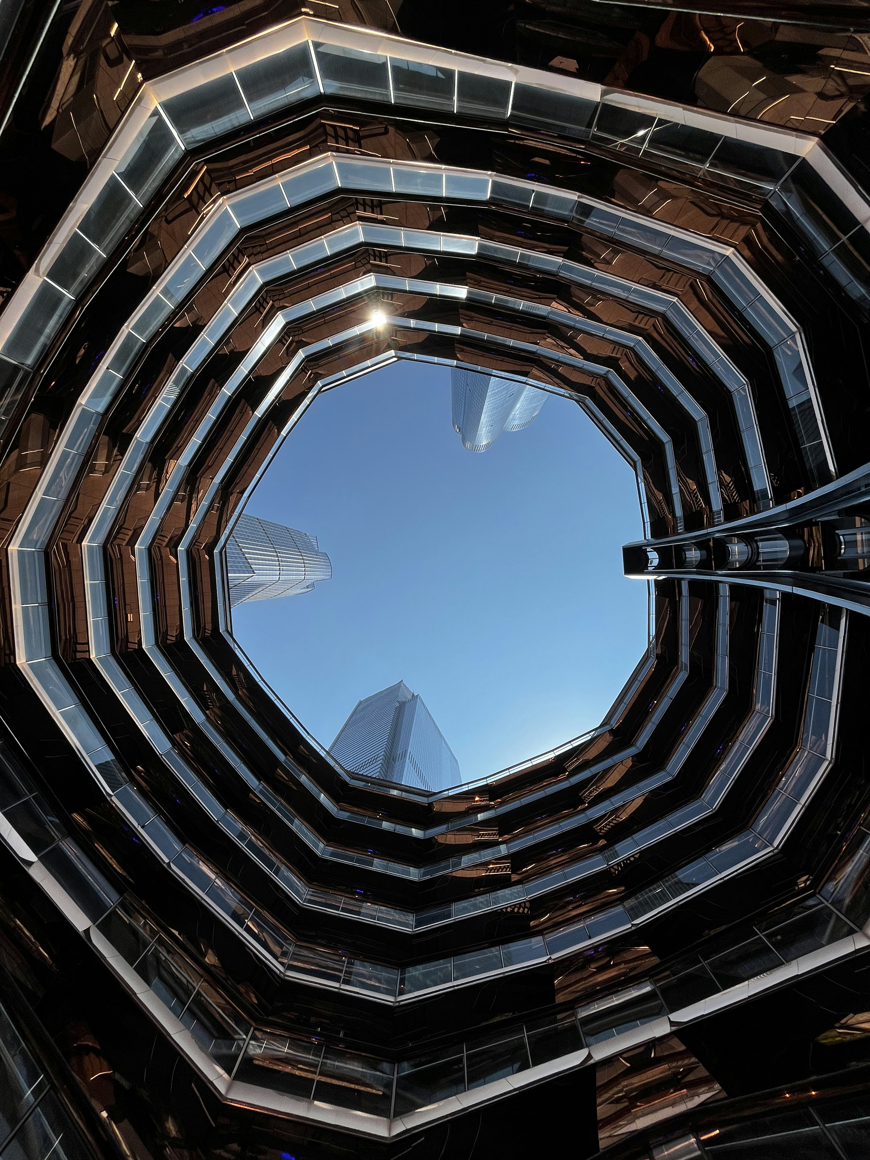 A very tall building with a very large circular window photo – Free New ...