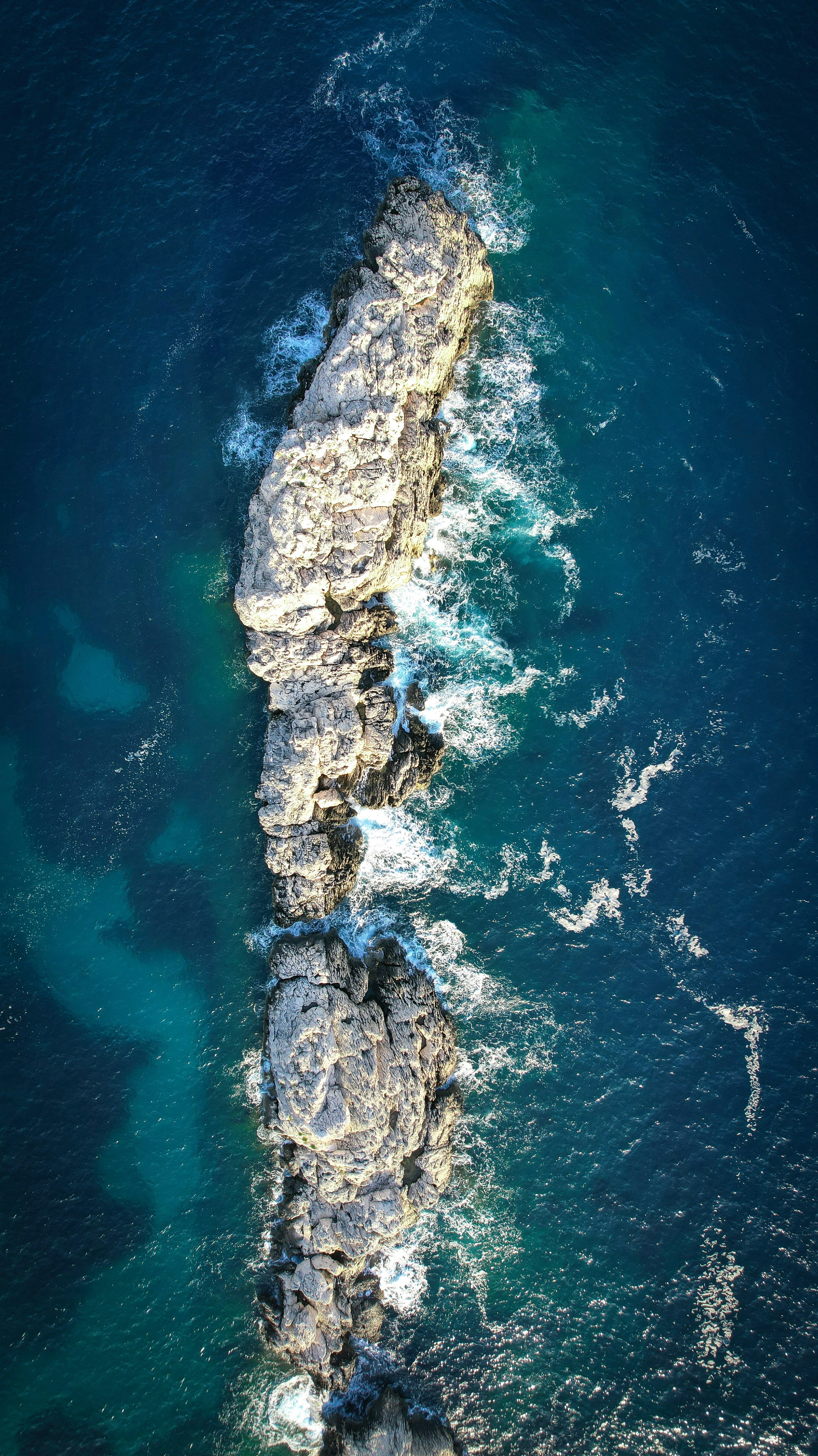 Rock Spine Piercing Turquoise Waters