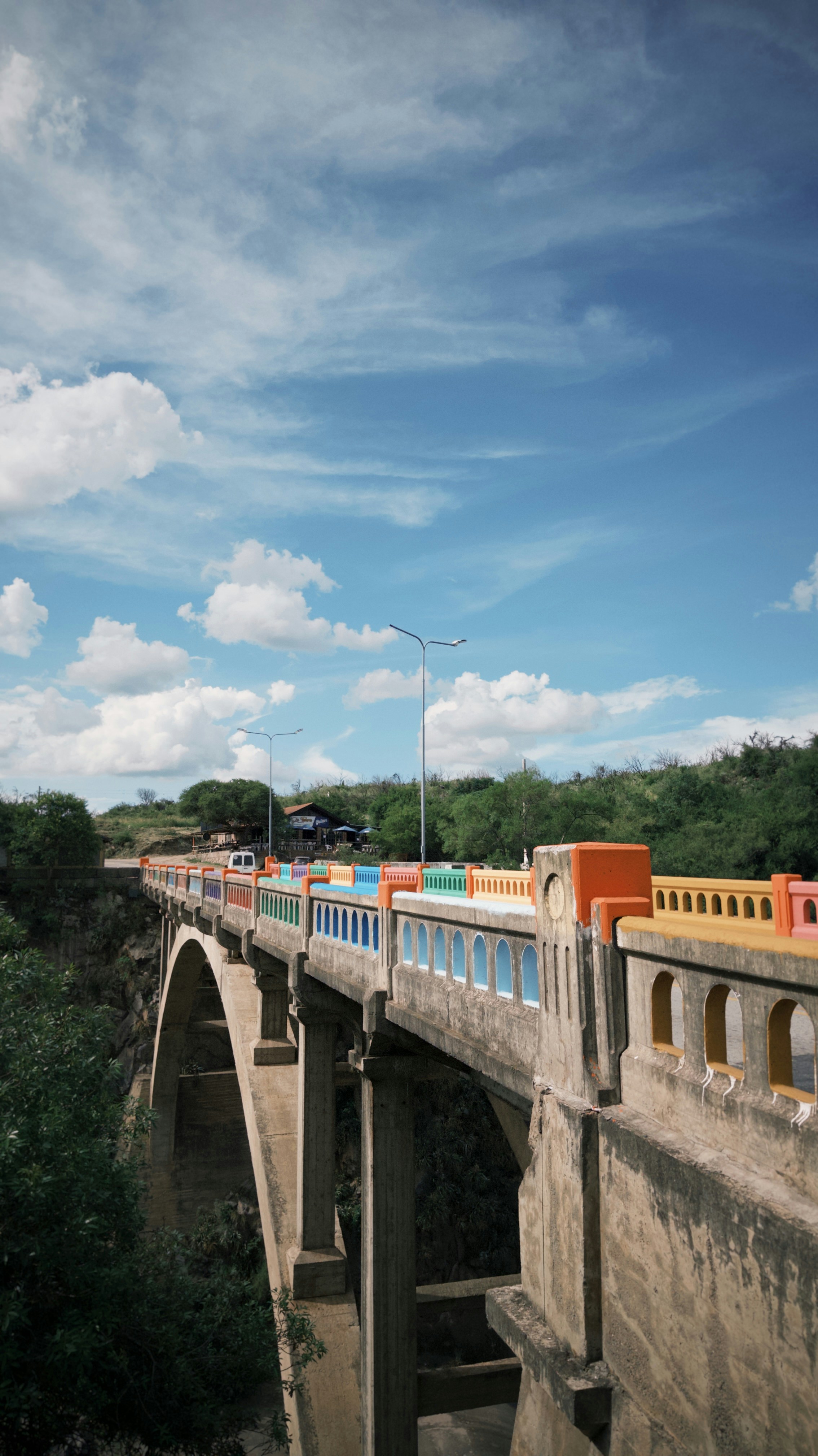 Rainbow Railings Over a Concrete Span Against a Clear Sky