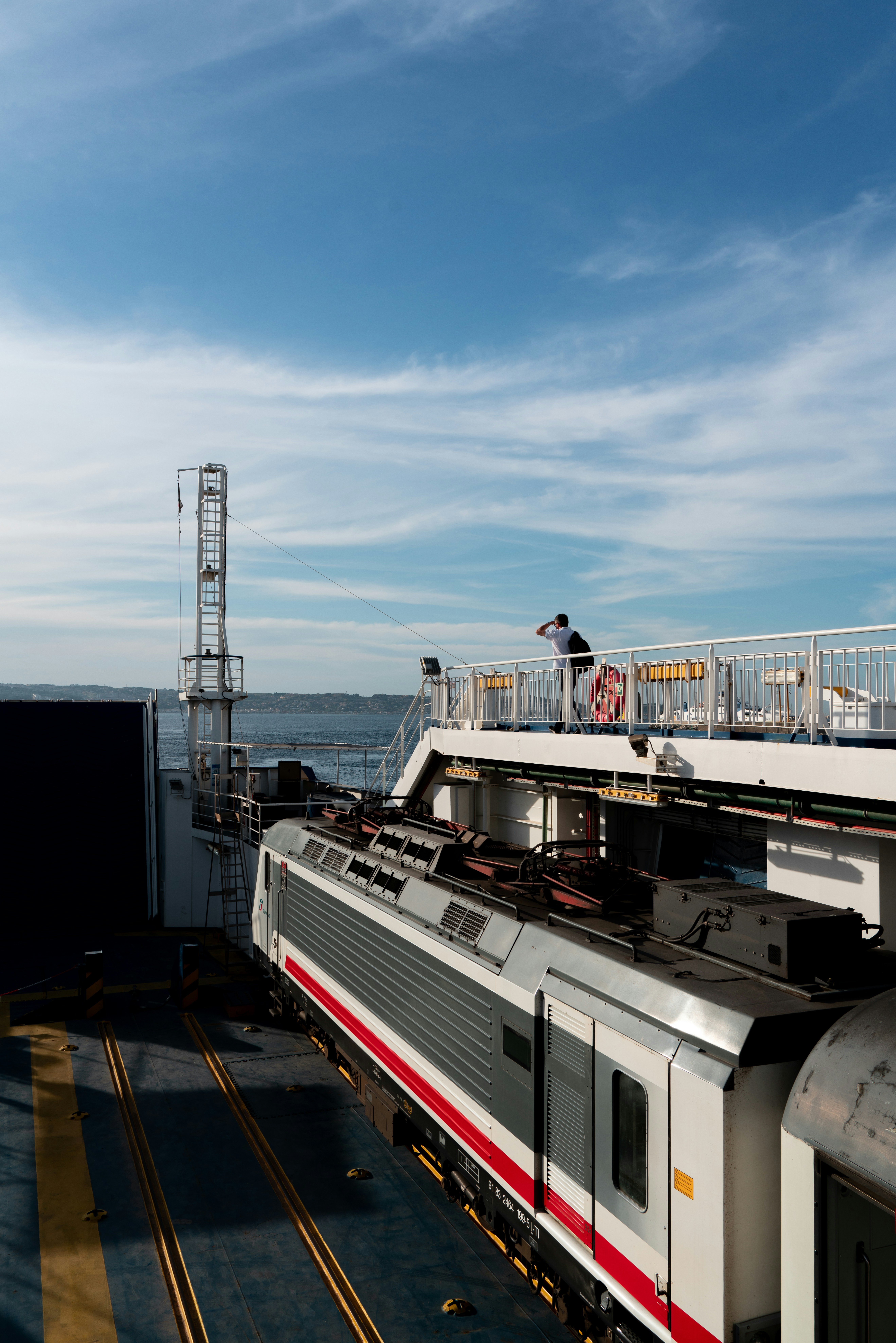 A white intercity train from trenitalia on the ferry between Messina and villa san giovanni