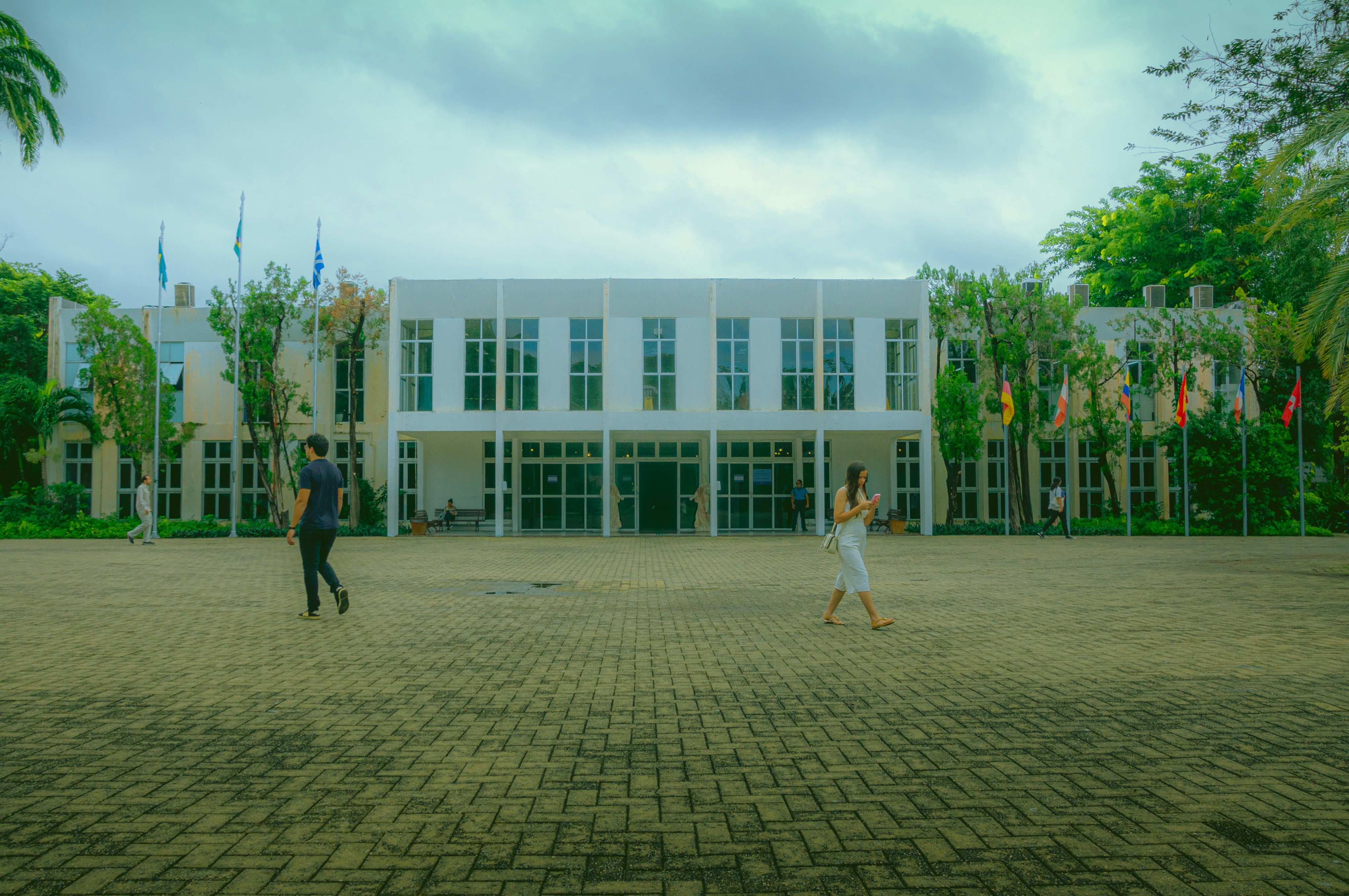 Parallel Paths at a Glass-Faced Campus Entrance