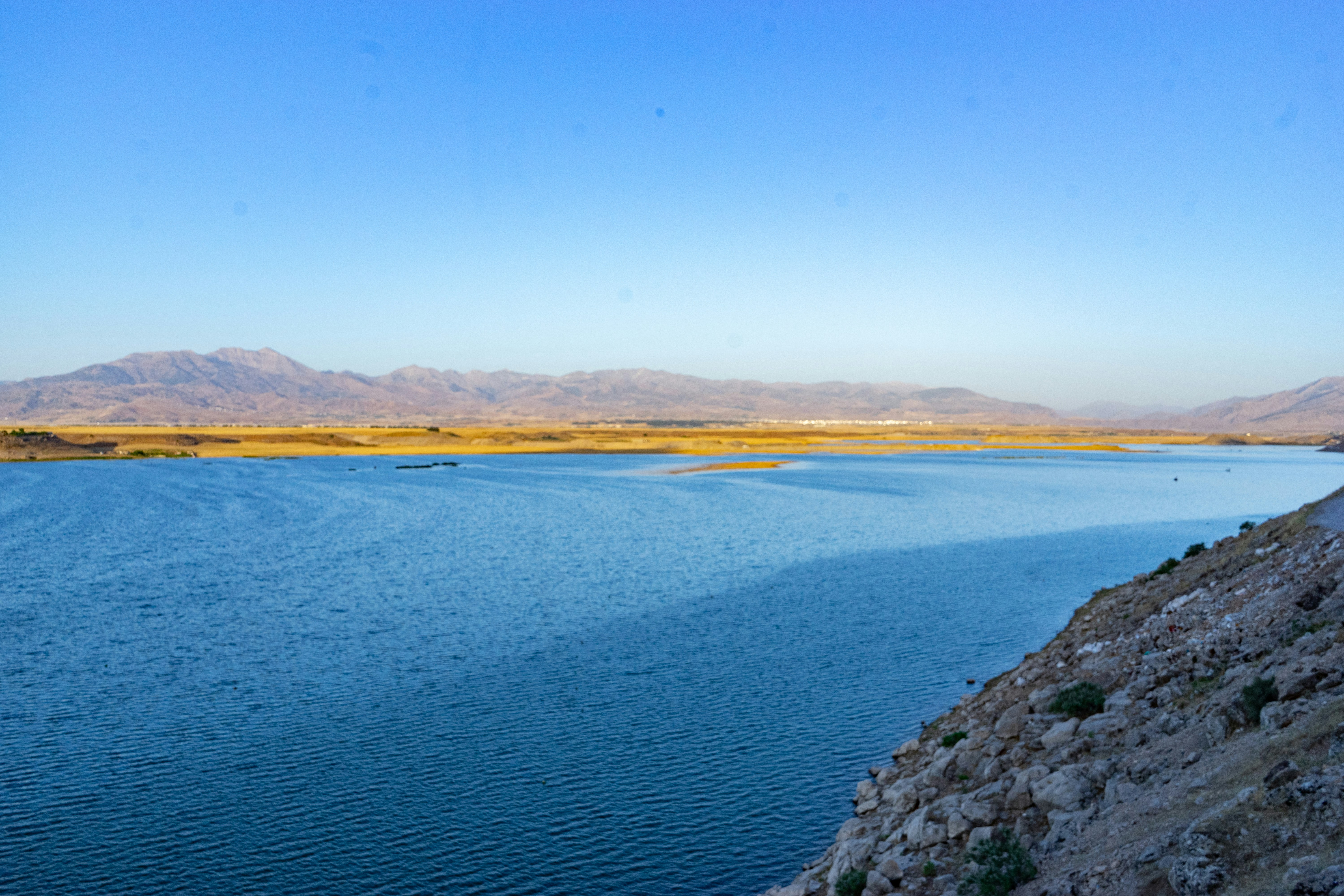 Azure Bend at the Desert Edge: Calm Lake Framing a Rugged Ridge