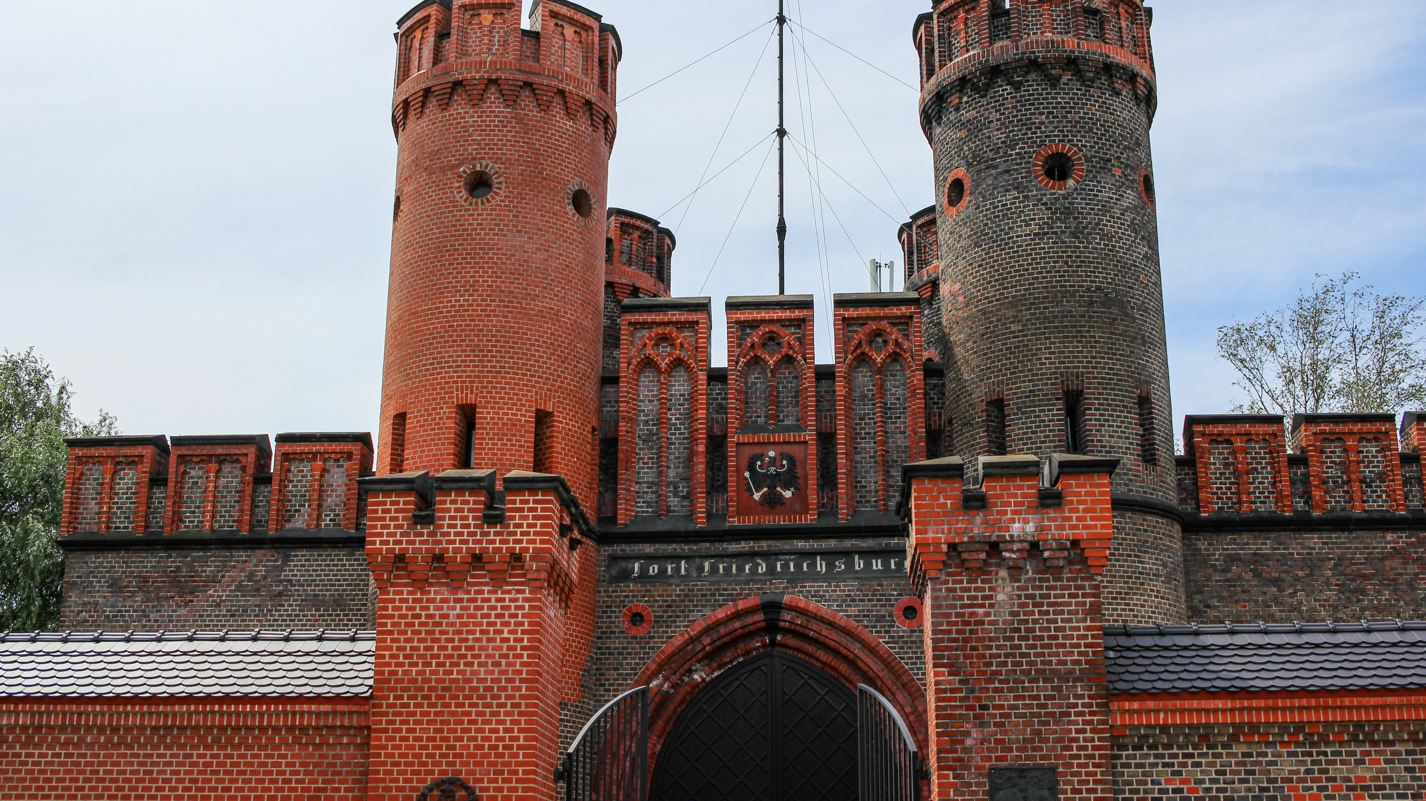 A large brick building with two towers on top of it photo – Free ...