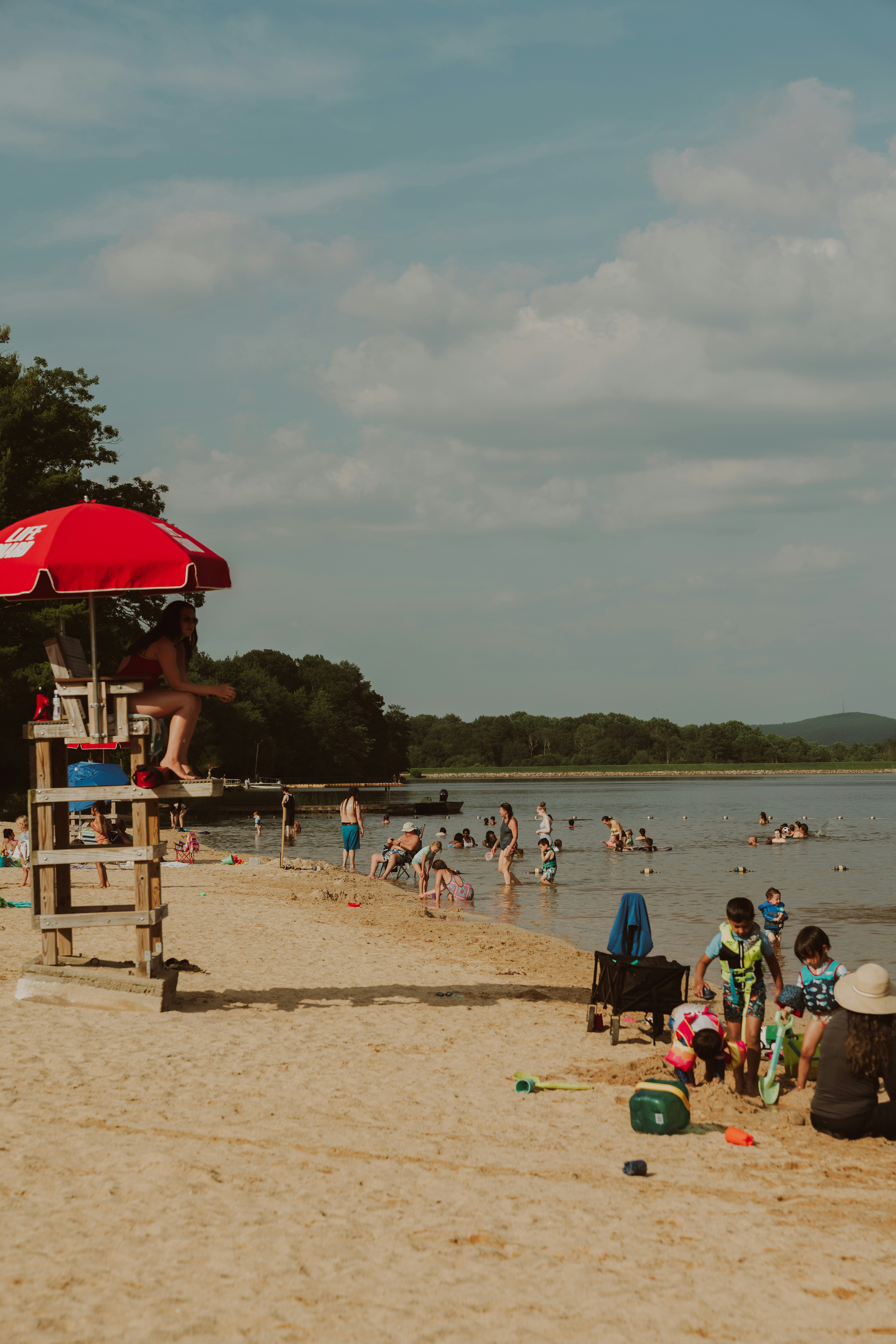 Red Umbrella Sentinel: Lifeguard Post Framing a Lively Beach