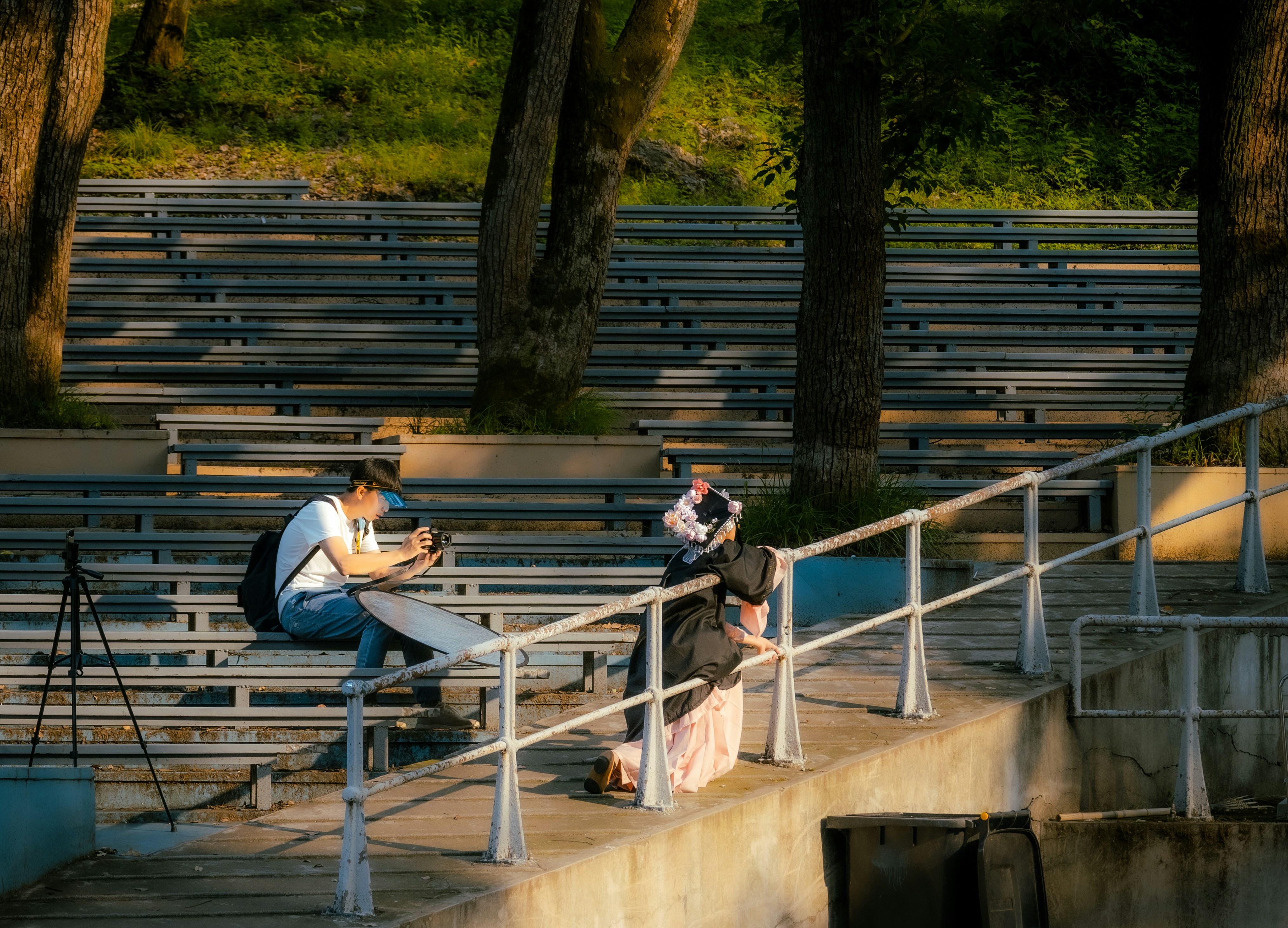 A couple of people sitting on top of bleachers photo – Free China Image ...
