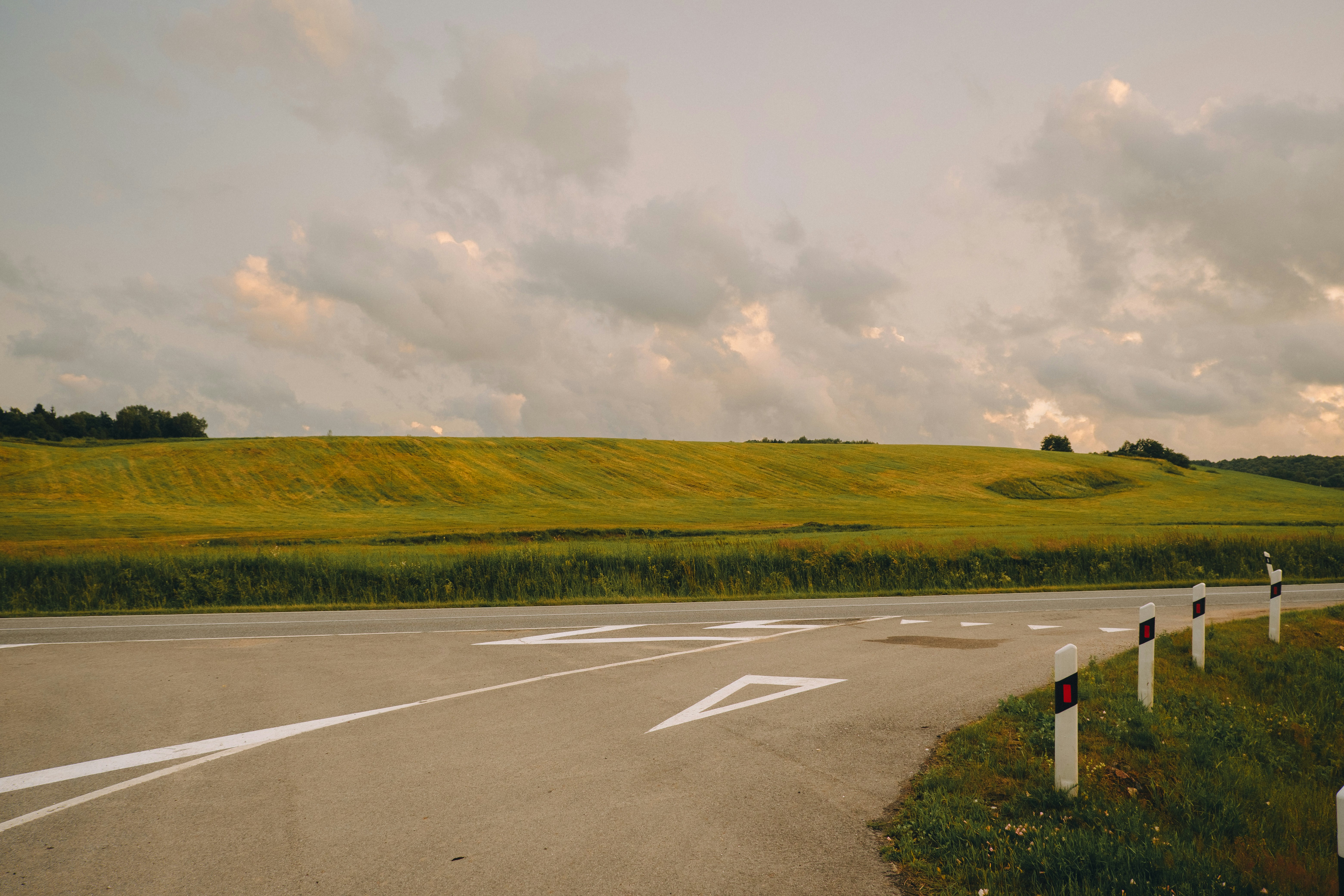 A paved road with a grassy field in the background photo – Free Road ...