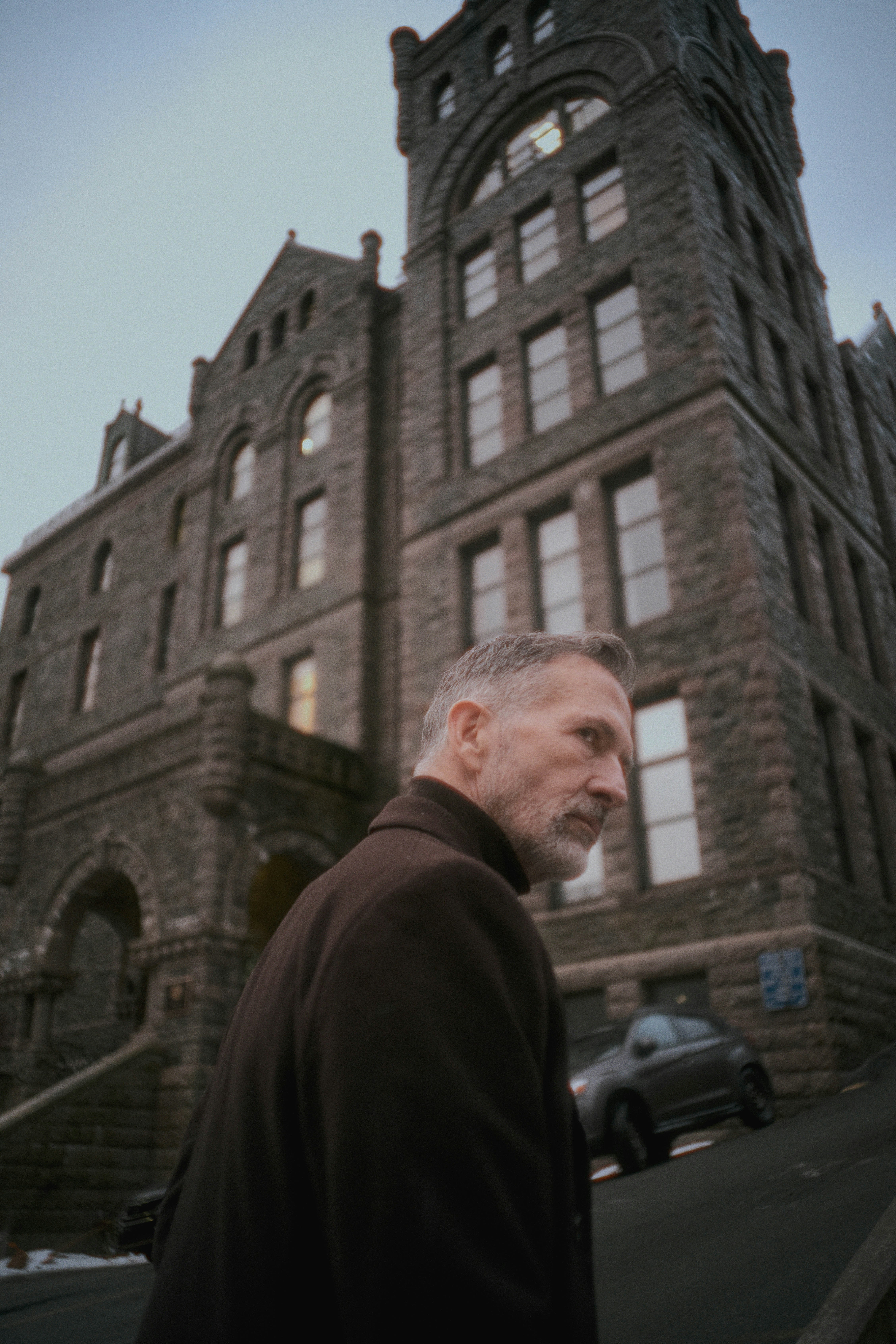 Low-Angle Portrait Before a Gothic Granite Facade