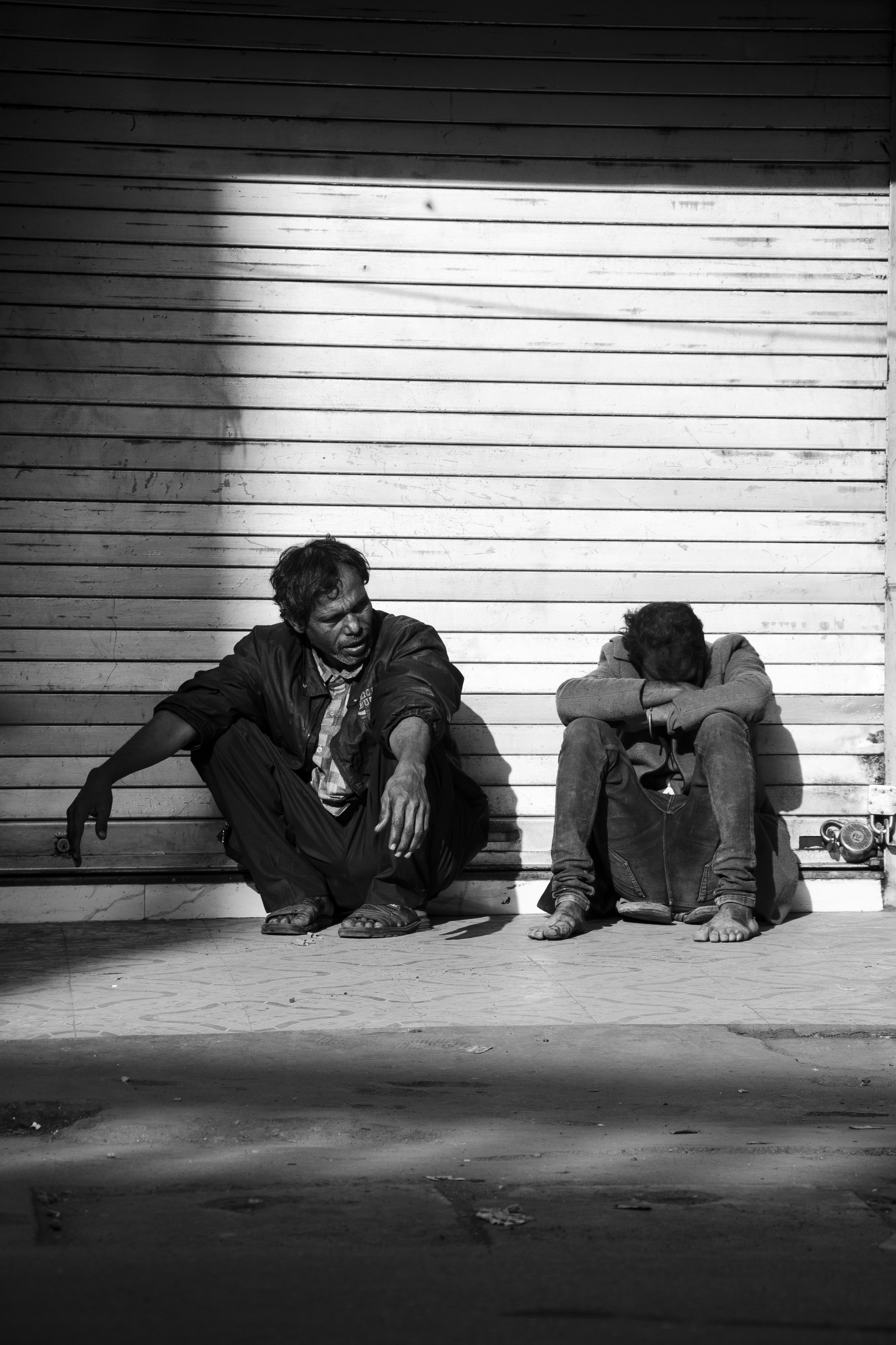 Two Strangers, One Shadowed Wall
