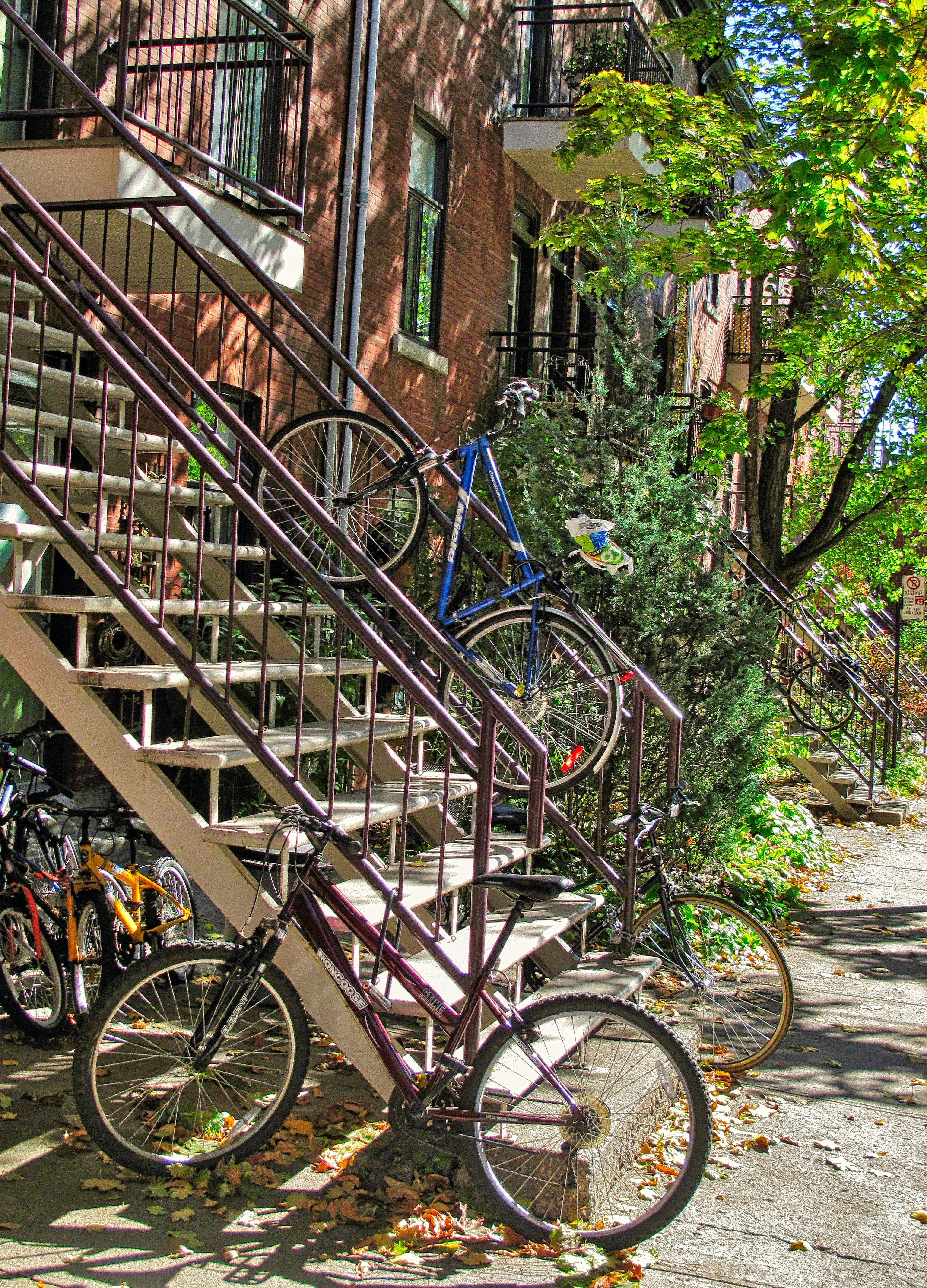 A couple of bikes parked next to a set of stairs photo – Free Montréal ...