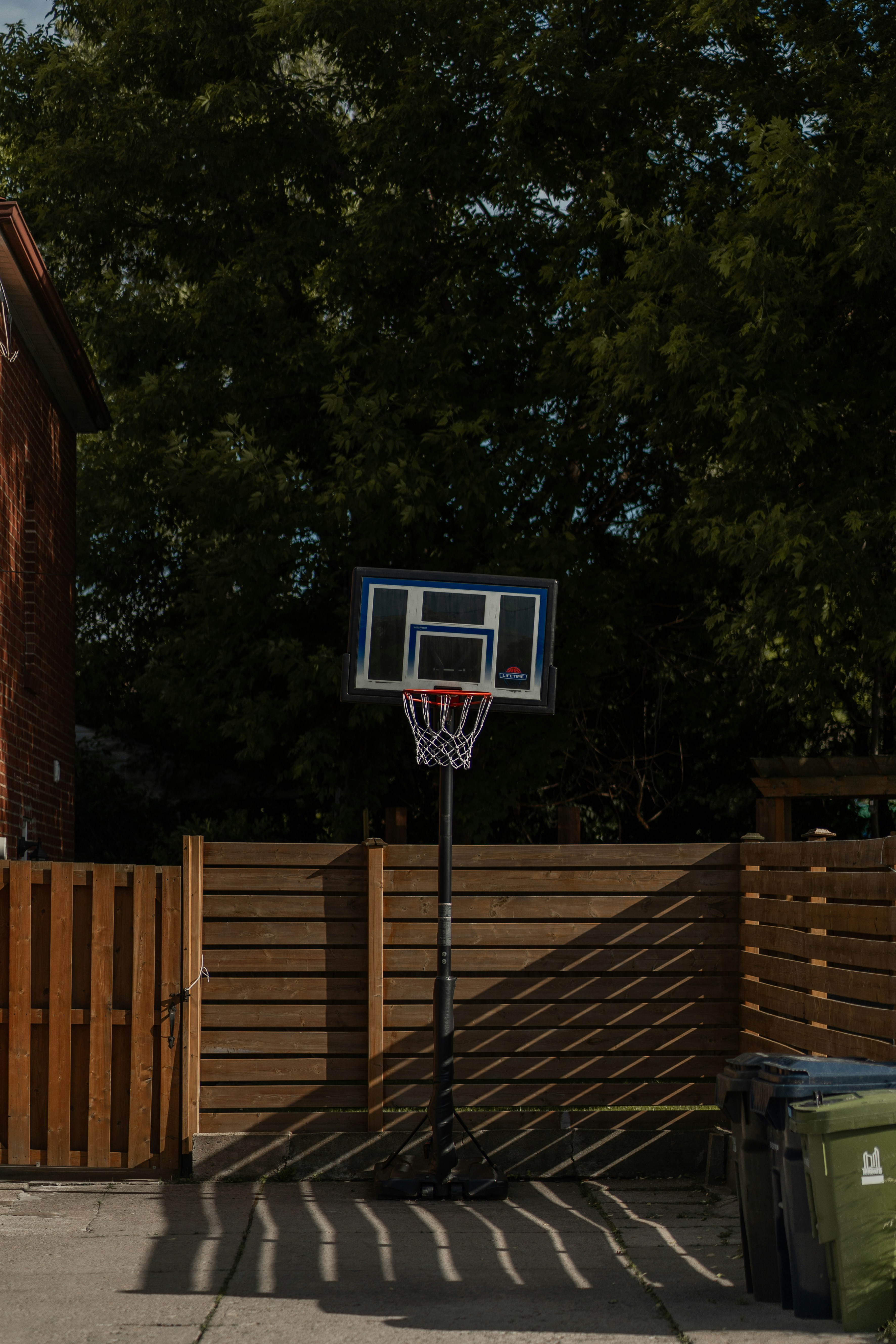 A basketball hoop in front of a brick building photo – Free Black Image ...