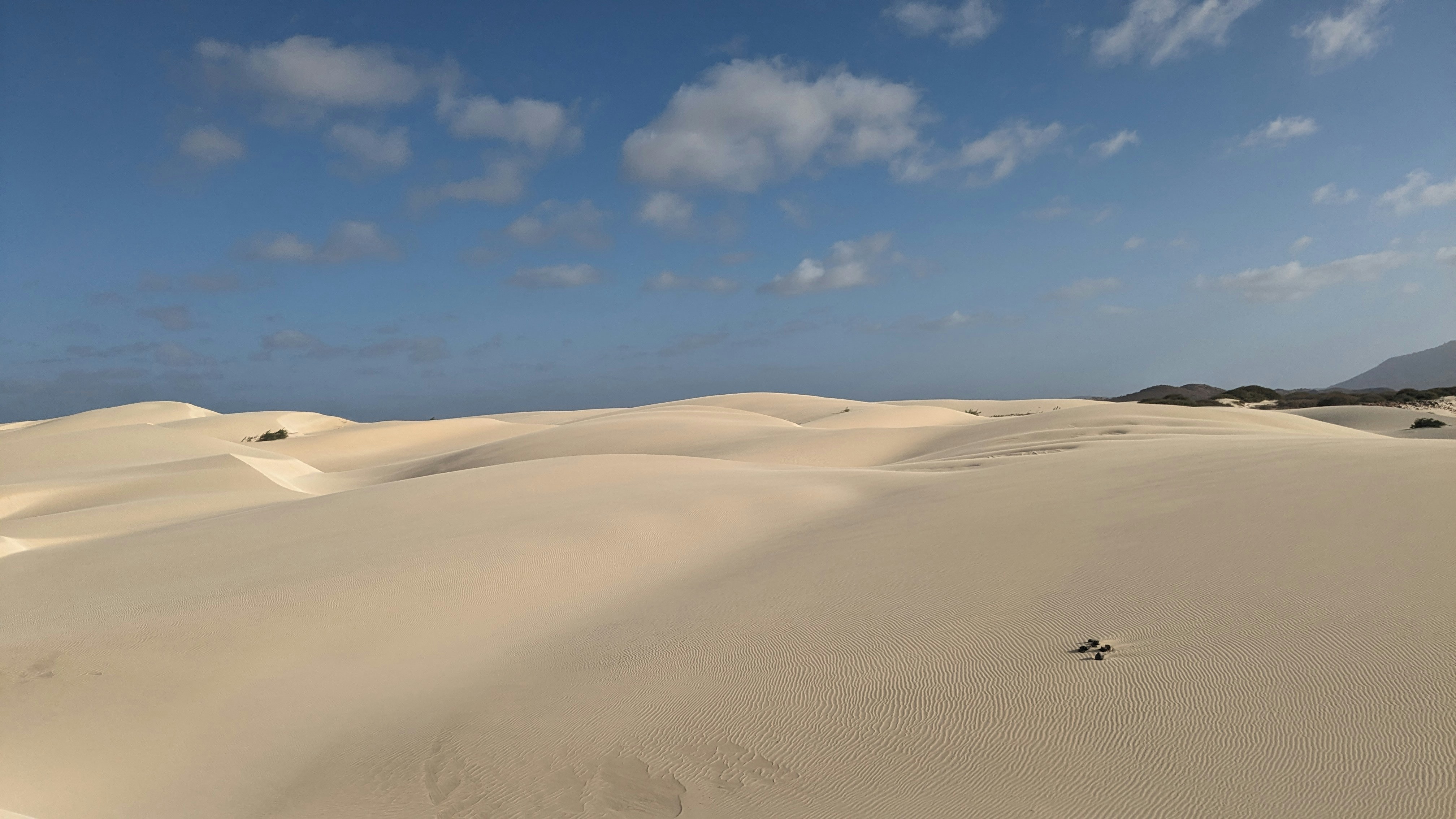 A group of people walking across a sandy field photo – Free Desert ...