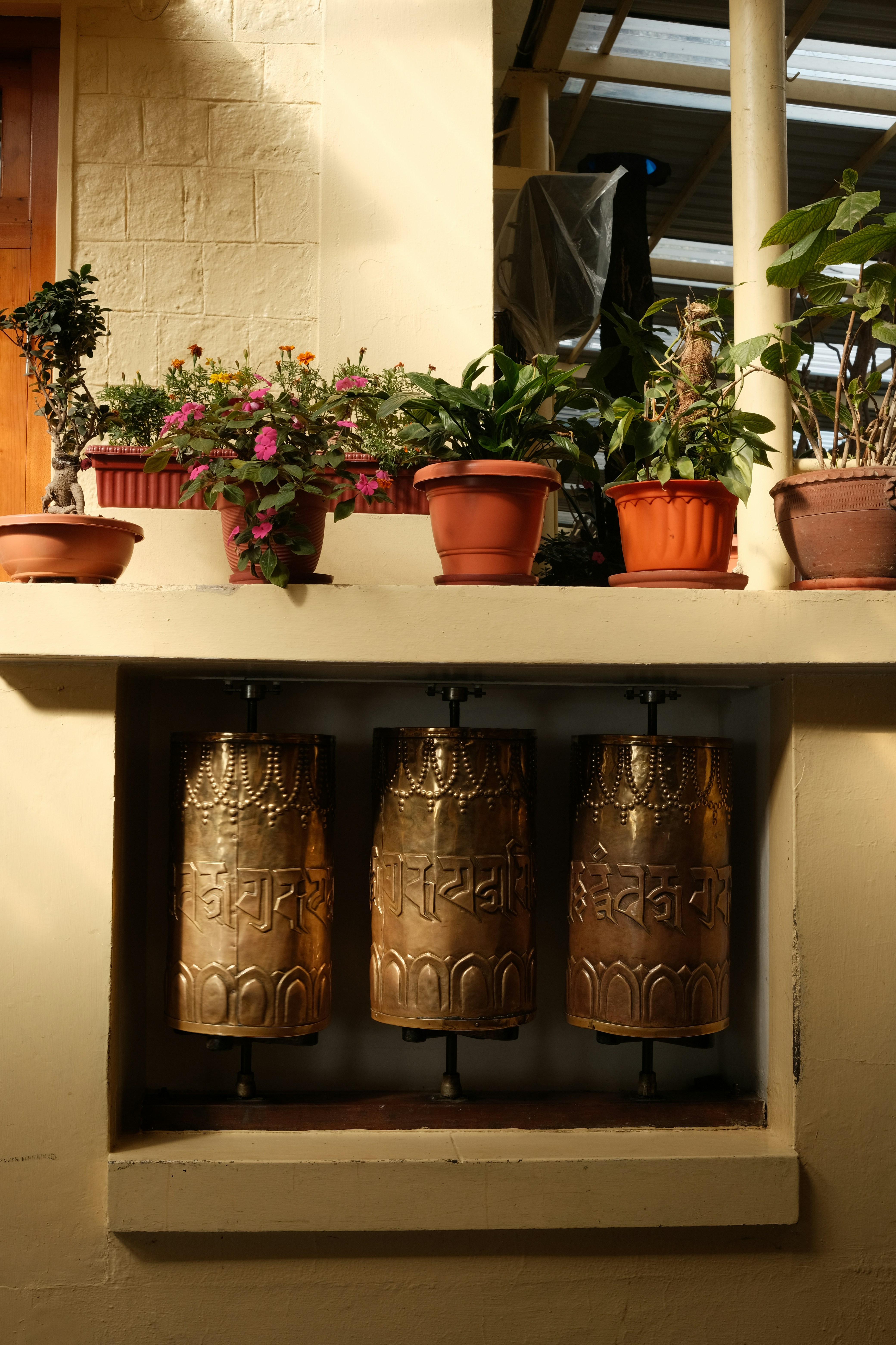 Copper Bells Under a Planter Roof: A Quiet Courtyard Moment