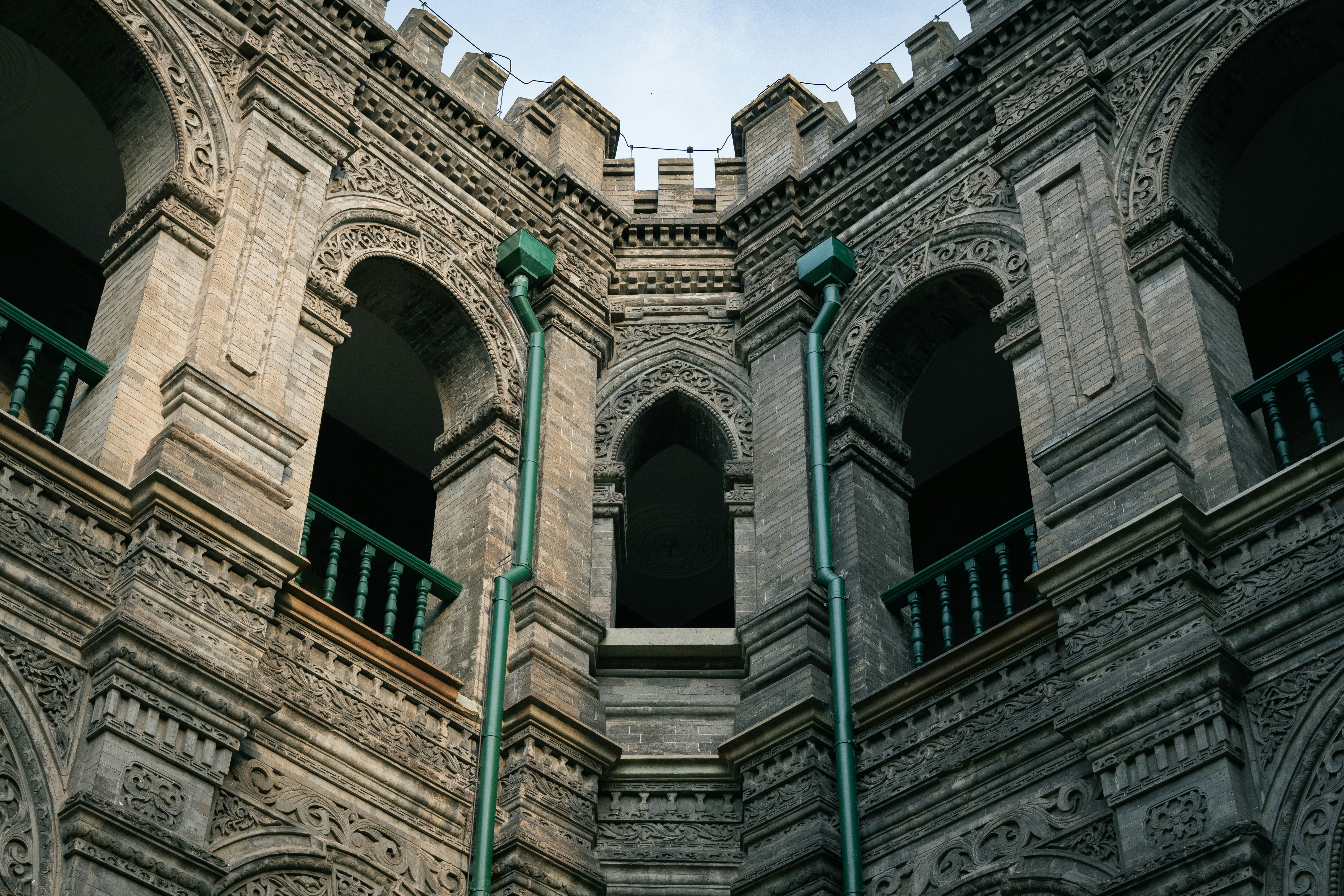 Crown of Arches: Intricate Stonework Framing a Courtyard Facade