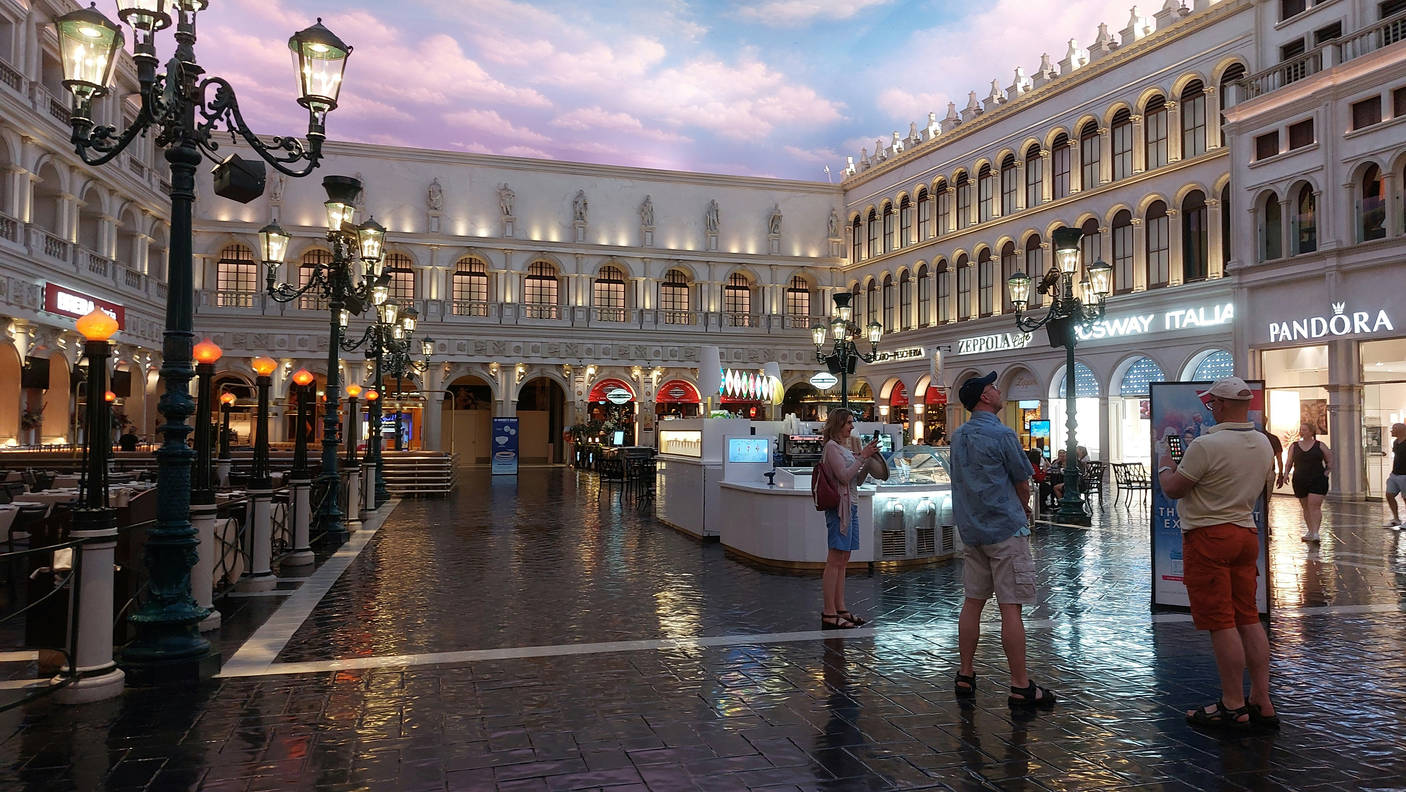Under Venetian Lights: A Quiet Piazza in a Grand Arcade