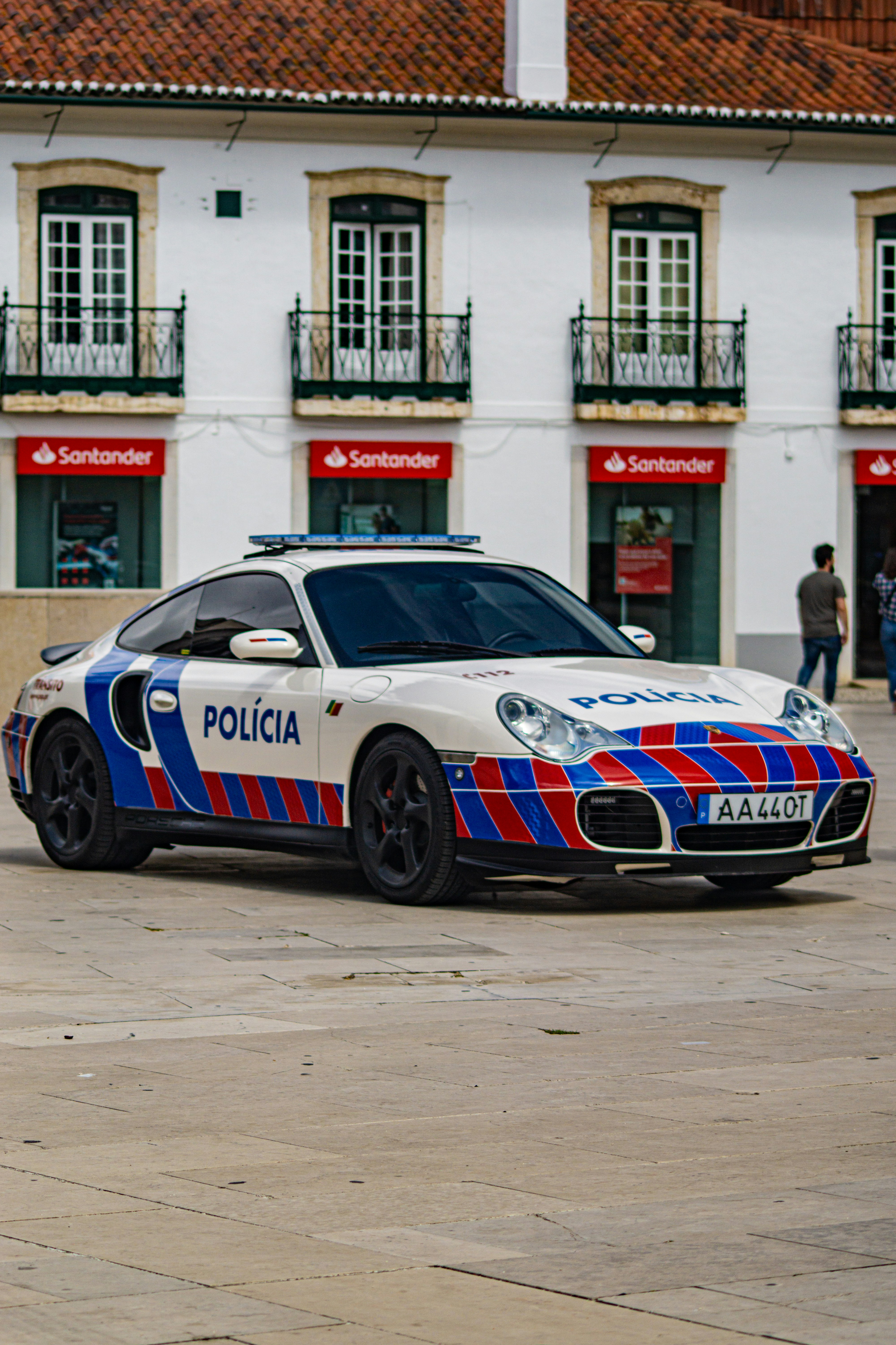 A police car parked in front of a building photo – Free Car Image on ...