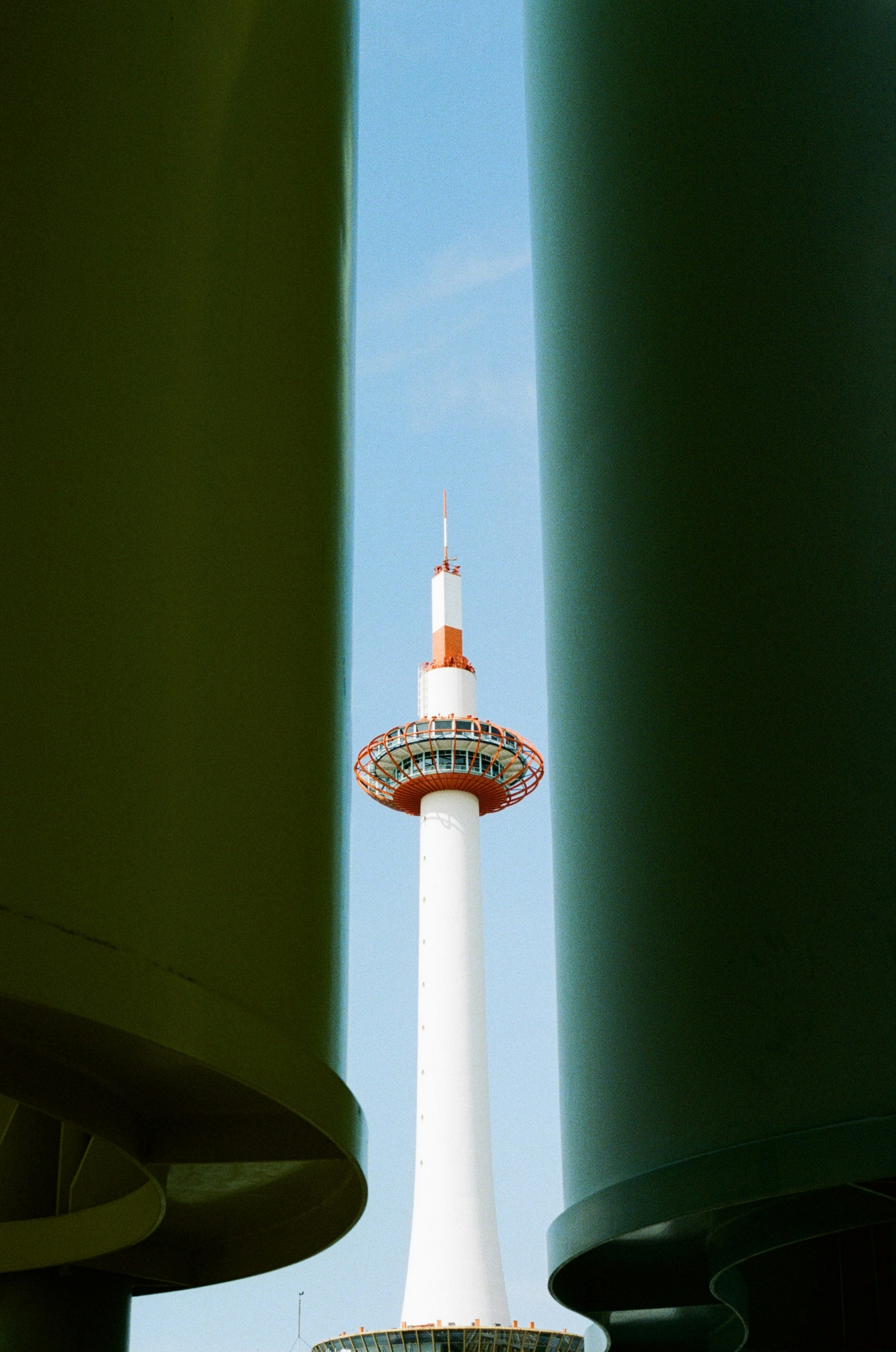 A tall white tower sitting next to two large green poles photo – Free ...