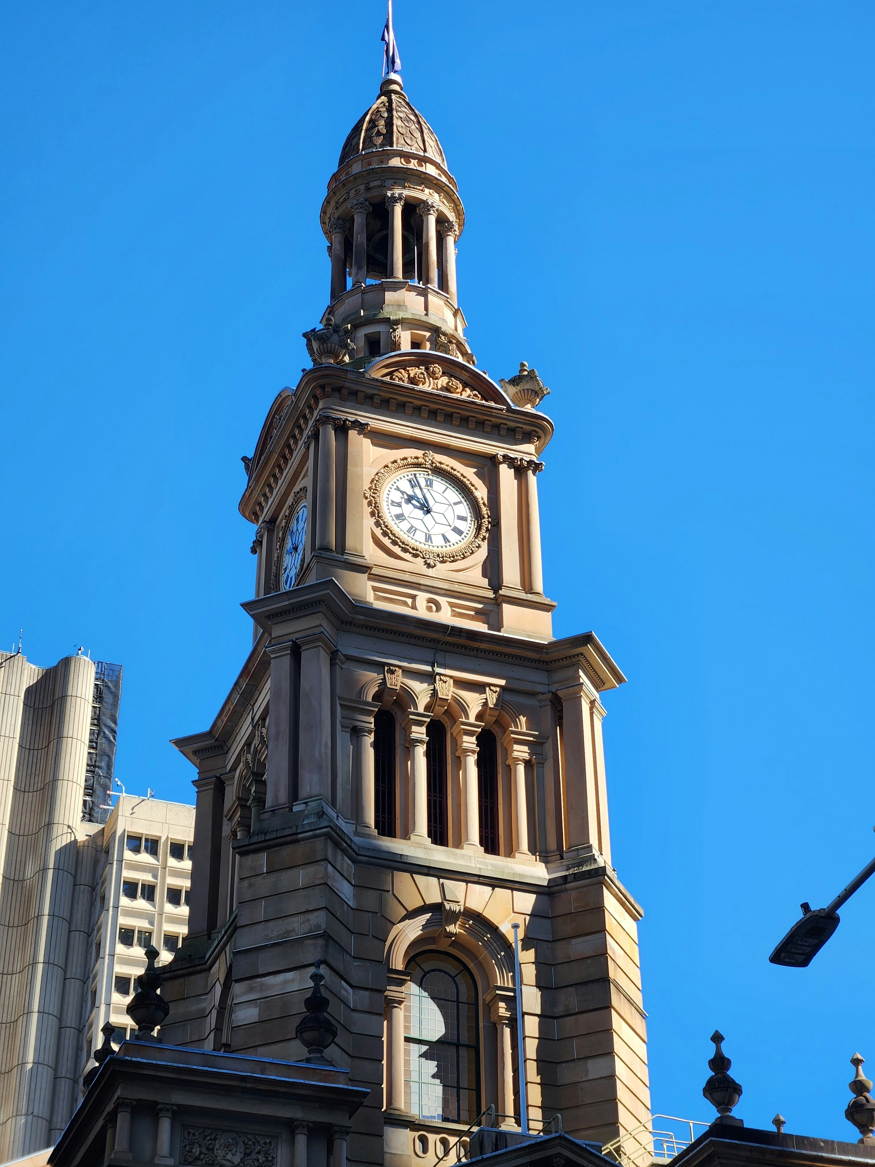 Ornate clock tower standing tall against a clear blue sky with intricate architectural details.