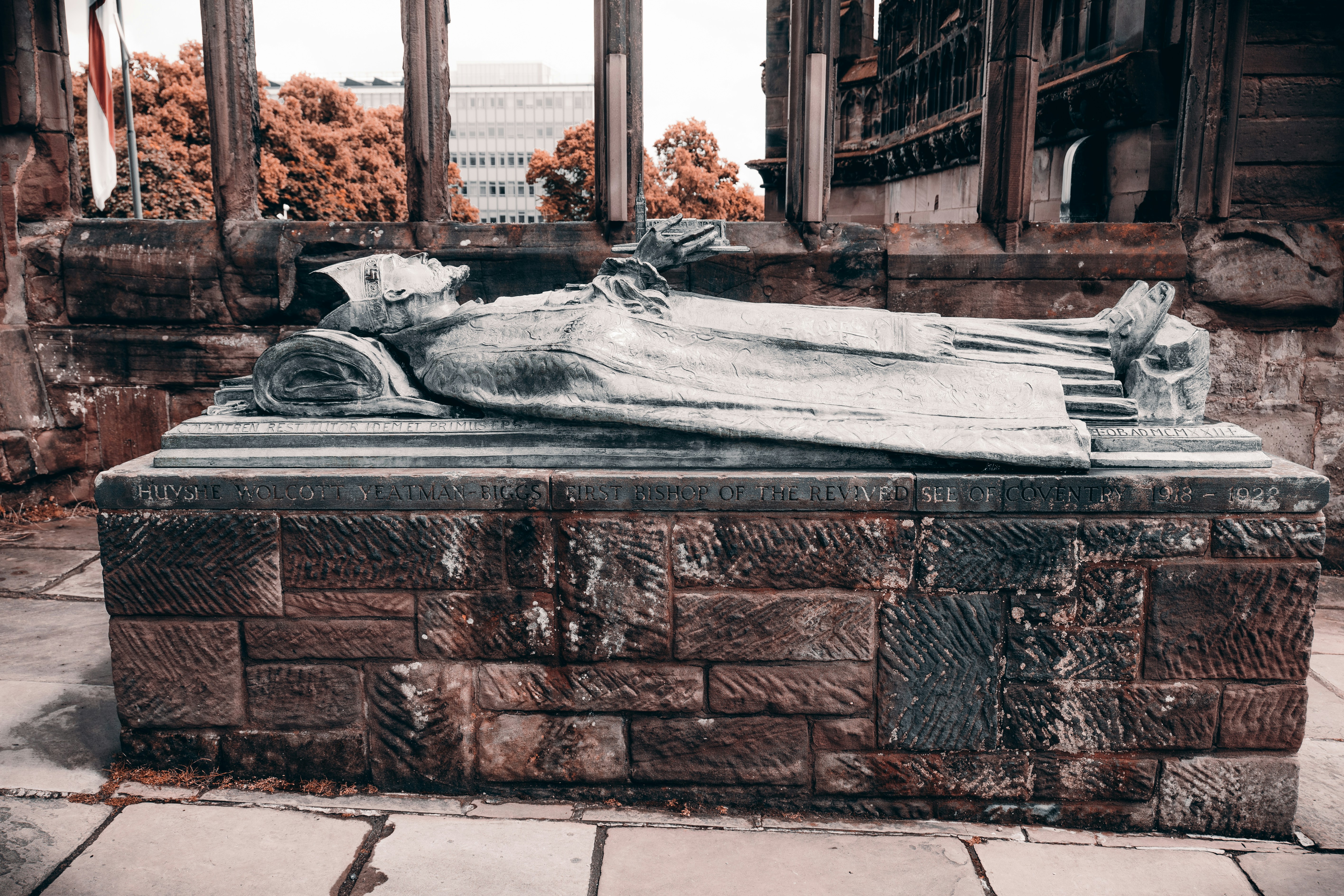 Reclining Sentinel on a Brick Plinth Beneath a Timber Shelter