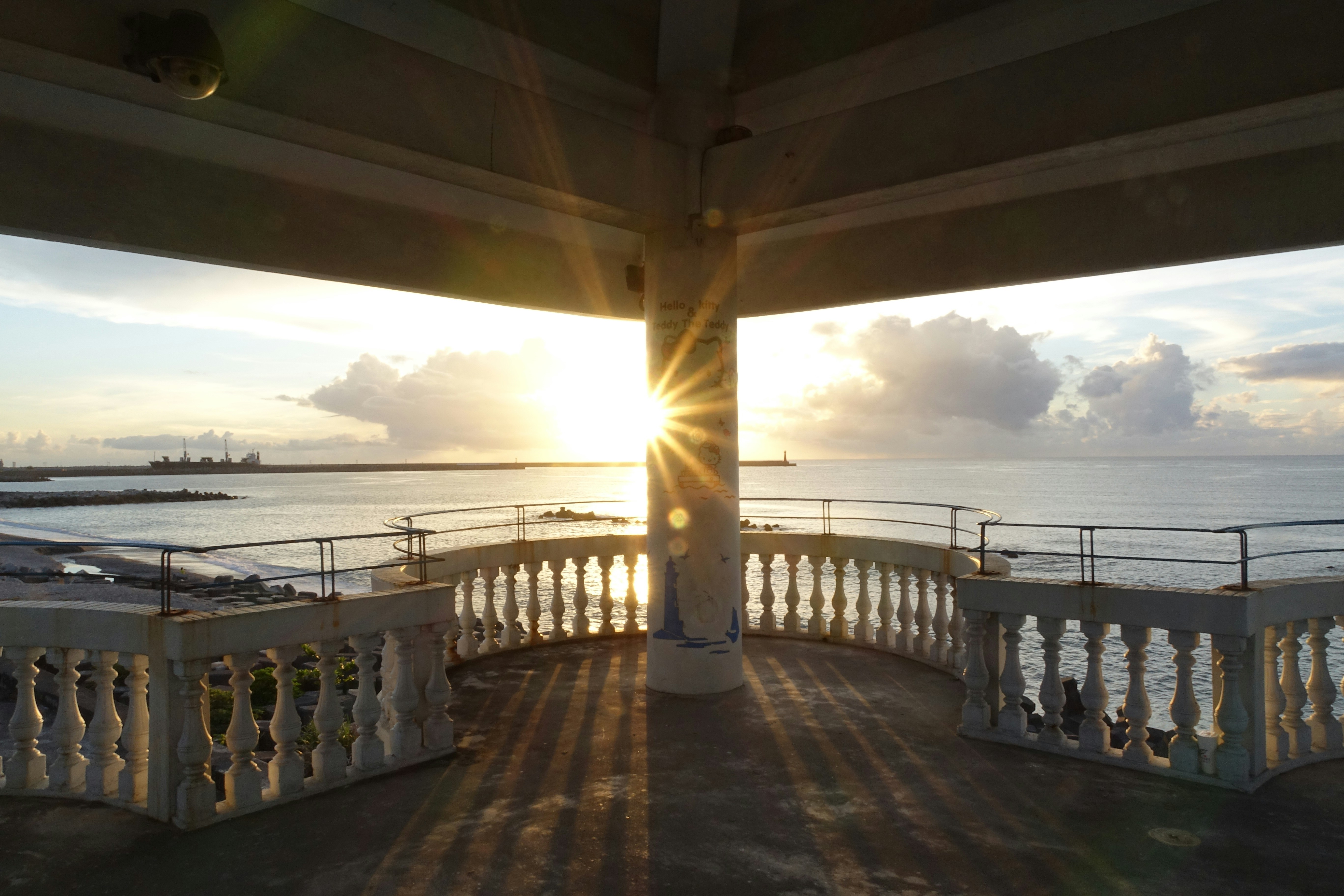 Sunburst Over a Seaside Gazebo: Quiet Light Framing the Horizon