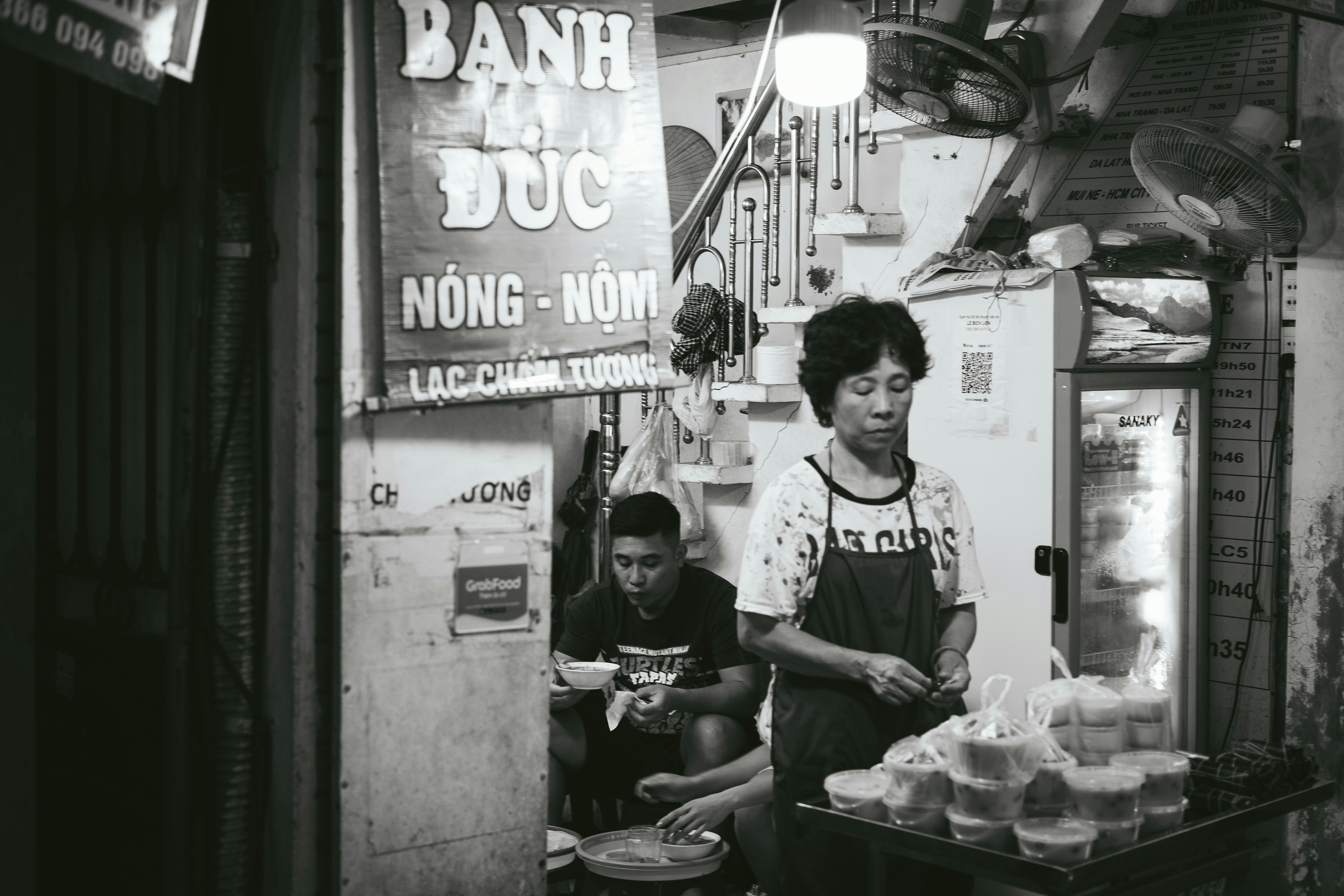 A woman standing in front of a store next to a man photo – Free Food ...