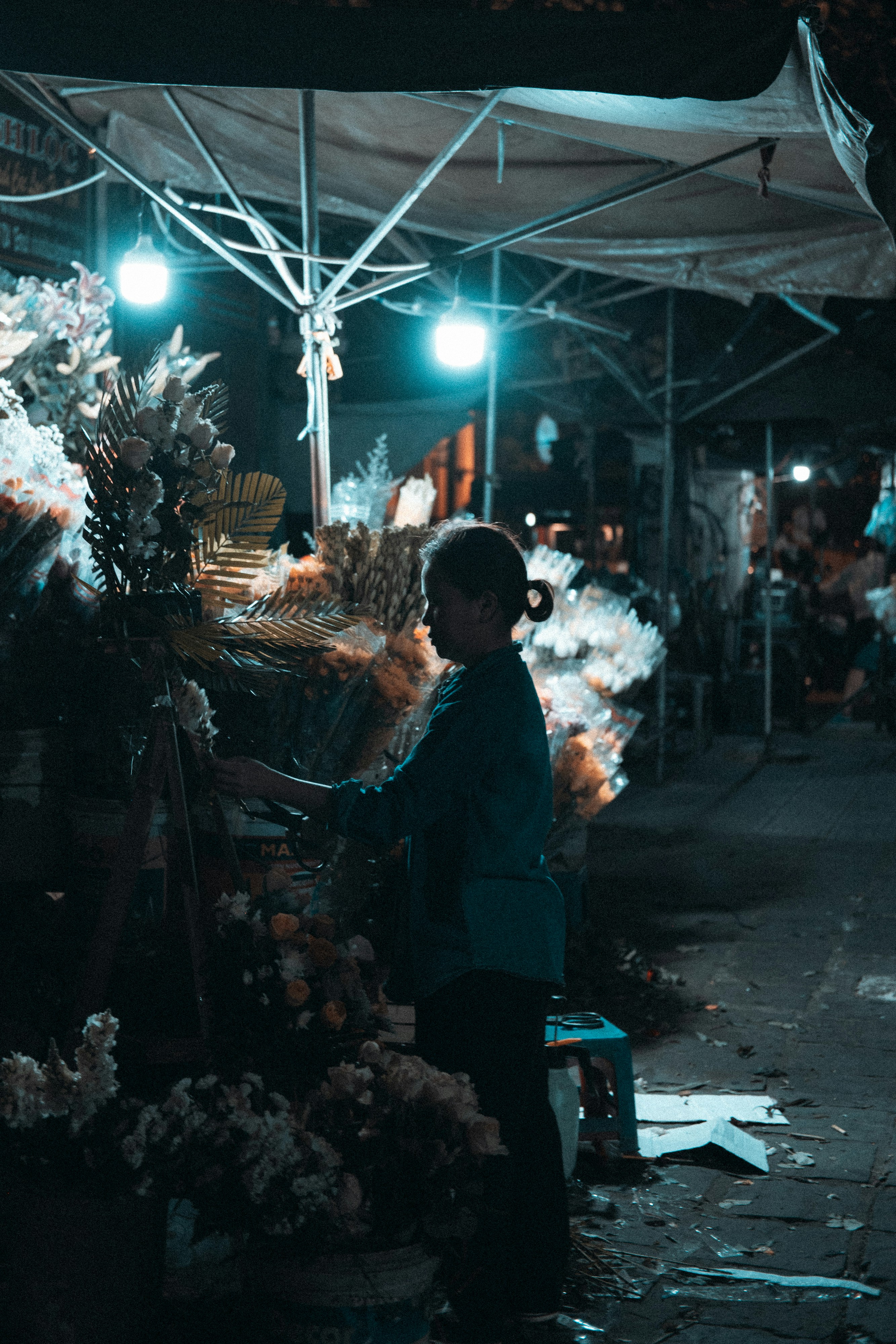 Under a Cyan Neon Canopy: the Night Market Flower Vendor