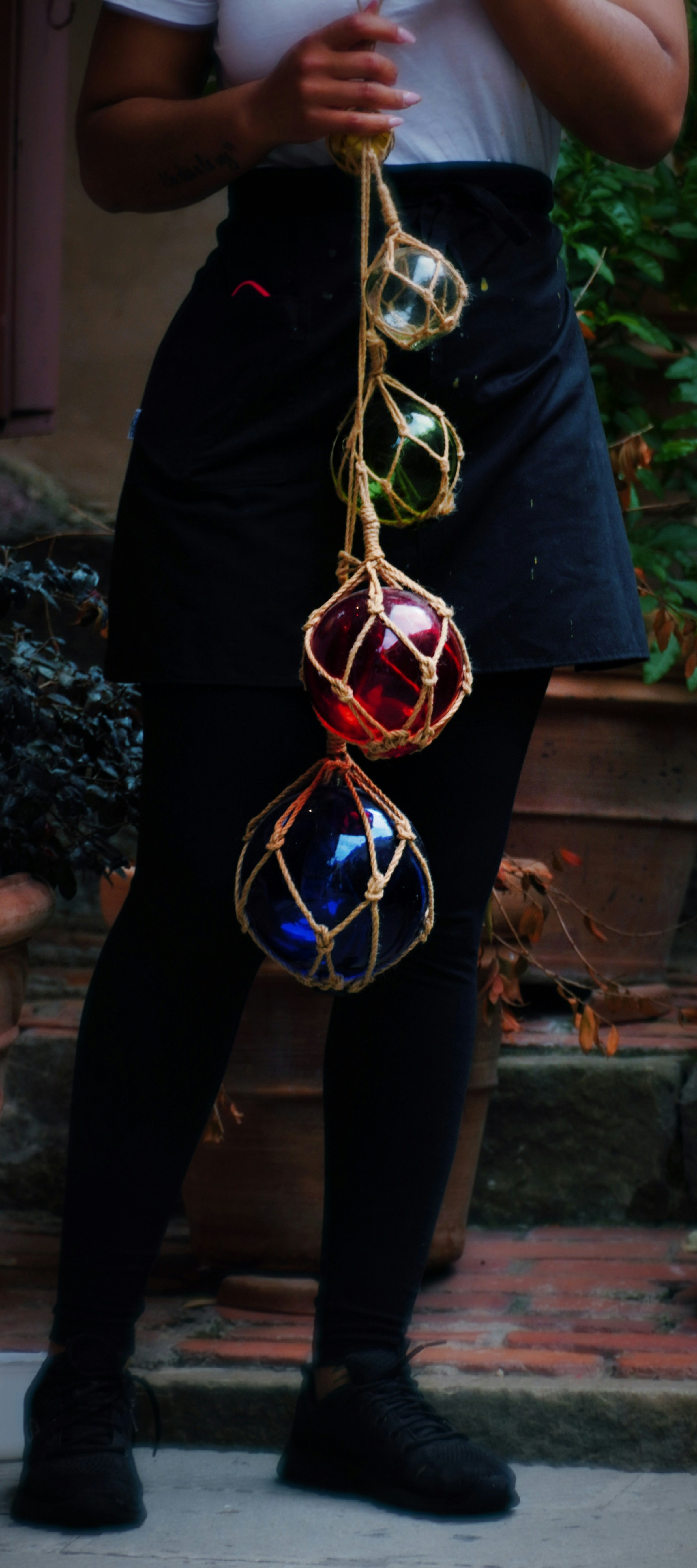 Colorful Glass Orbs Draped in Rustic Rope: A Portrait of Craft and Contrast
