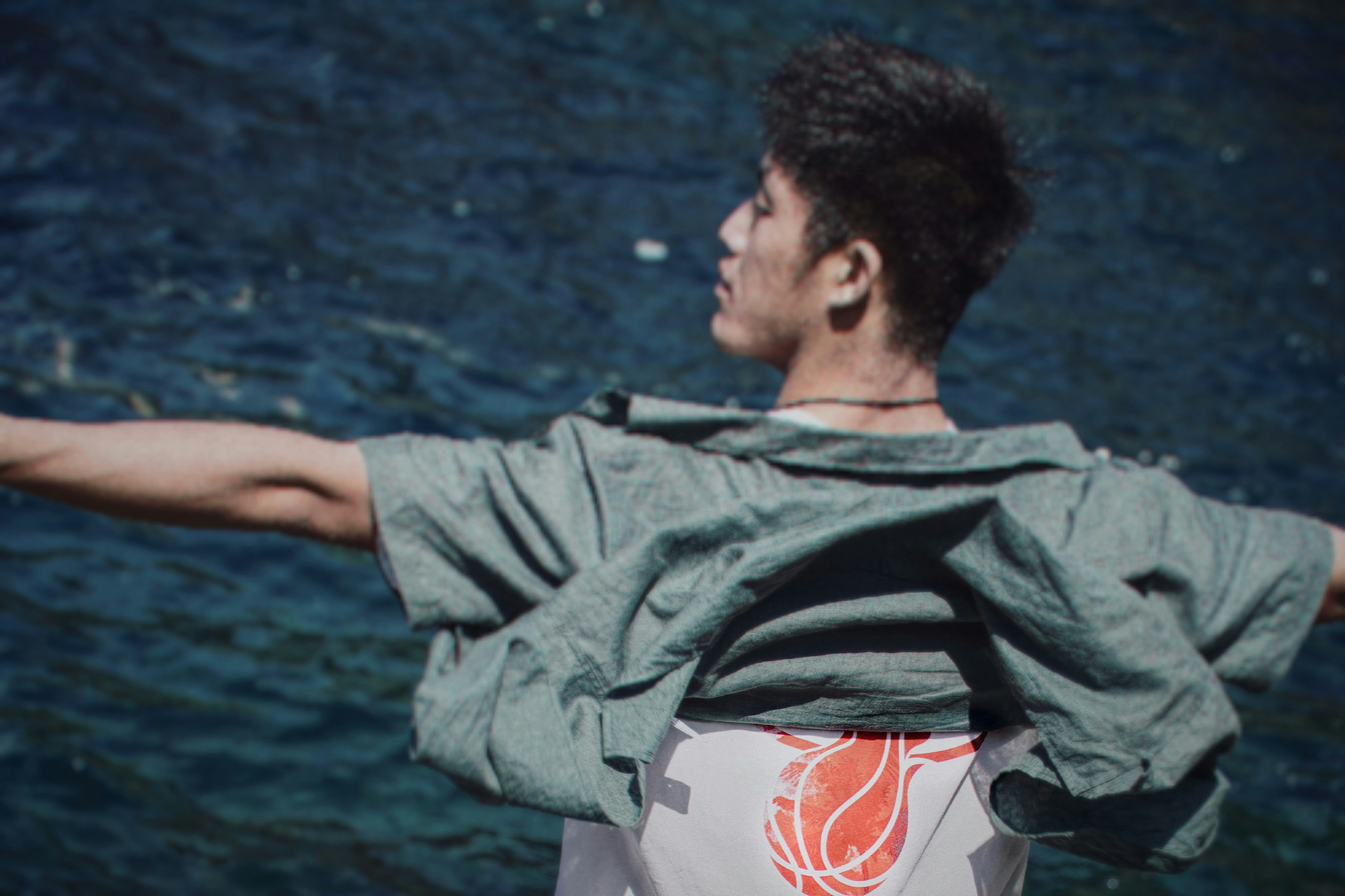 Arms Outstretched Over the Azure Sea