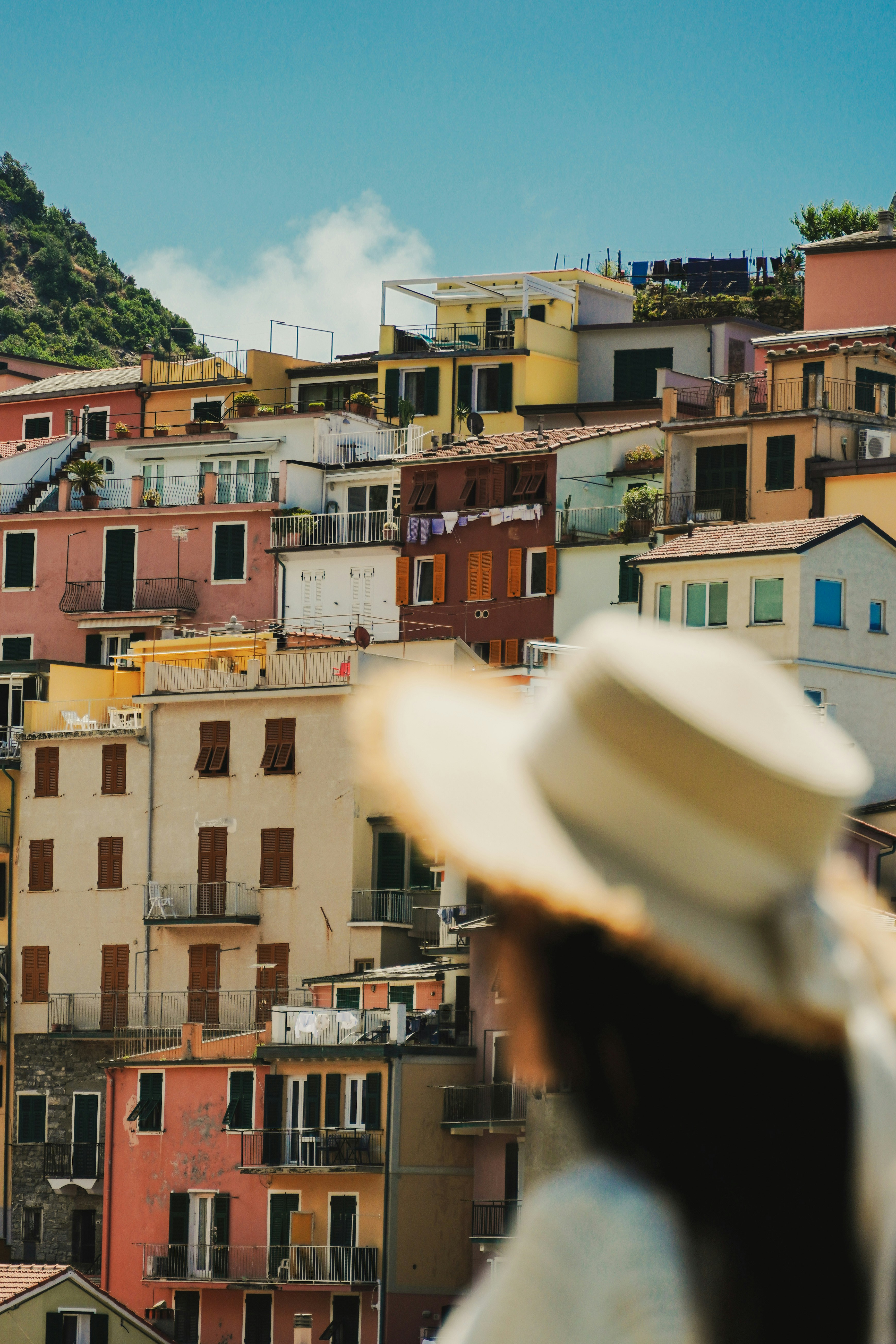 Patchwork Hillside: Colorful Balconies in a Sunlit Town