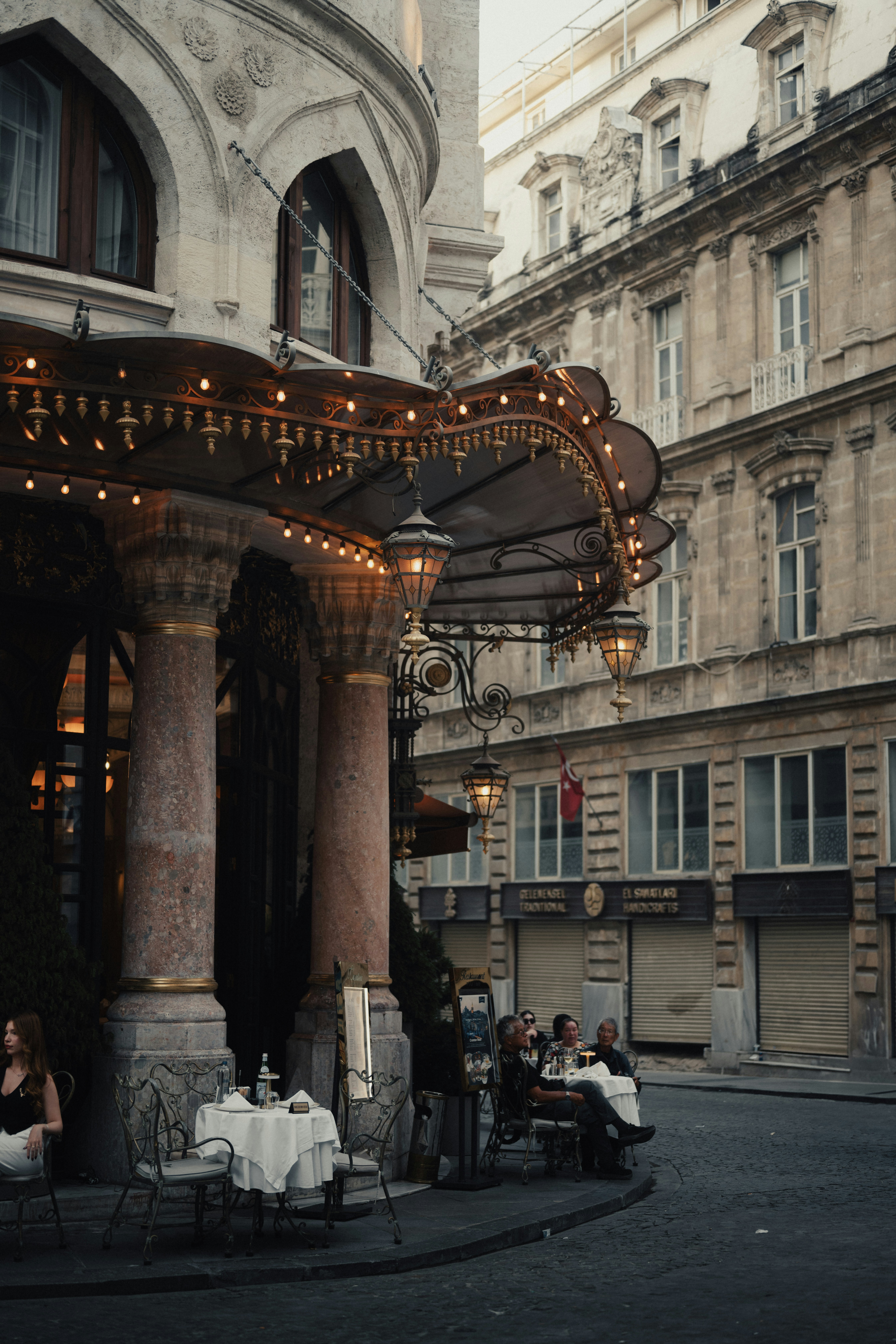 Lanterns and Lace: A Parisian Café Under an Ornate Canopy