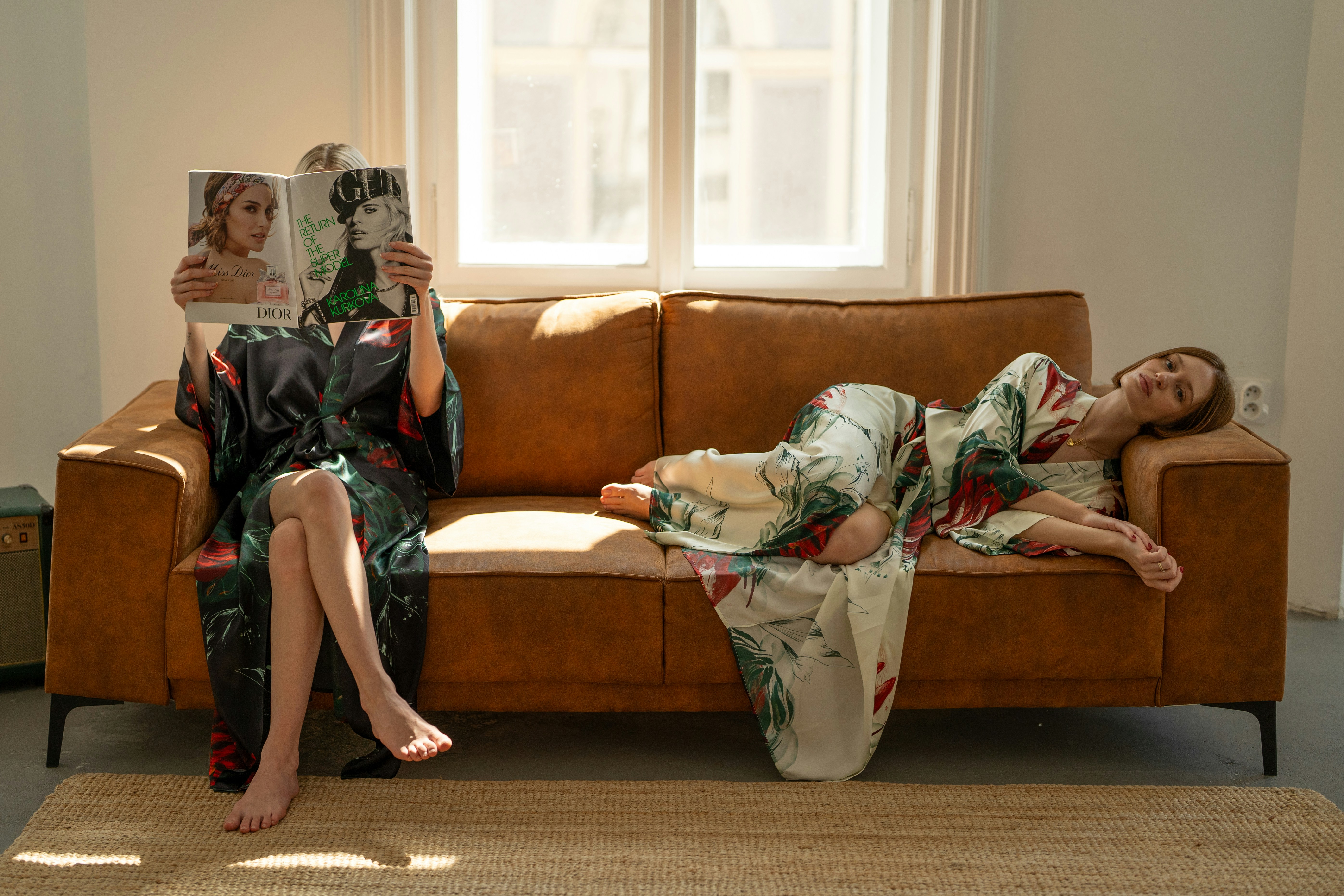 Sunlit Livingroom Portrait: Silk Robes and Quiet Recline on a Leather Sofa