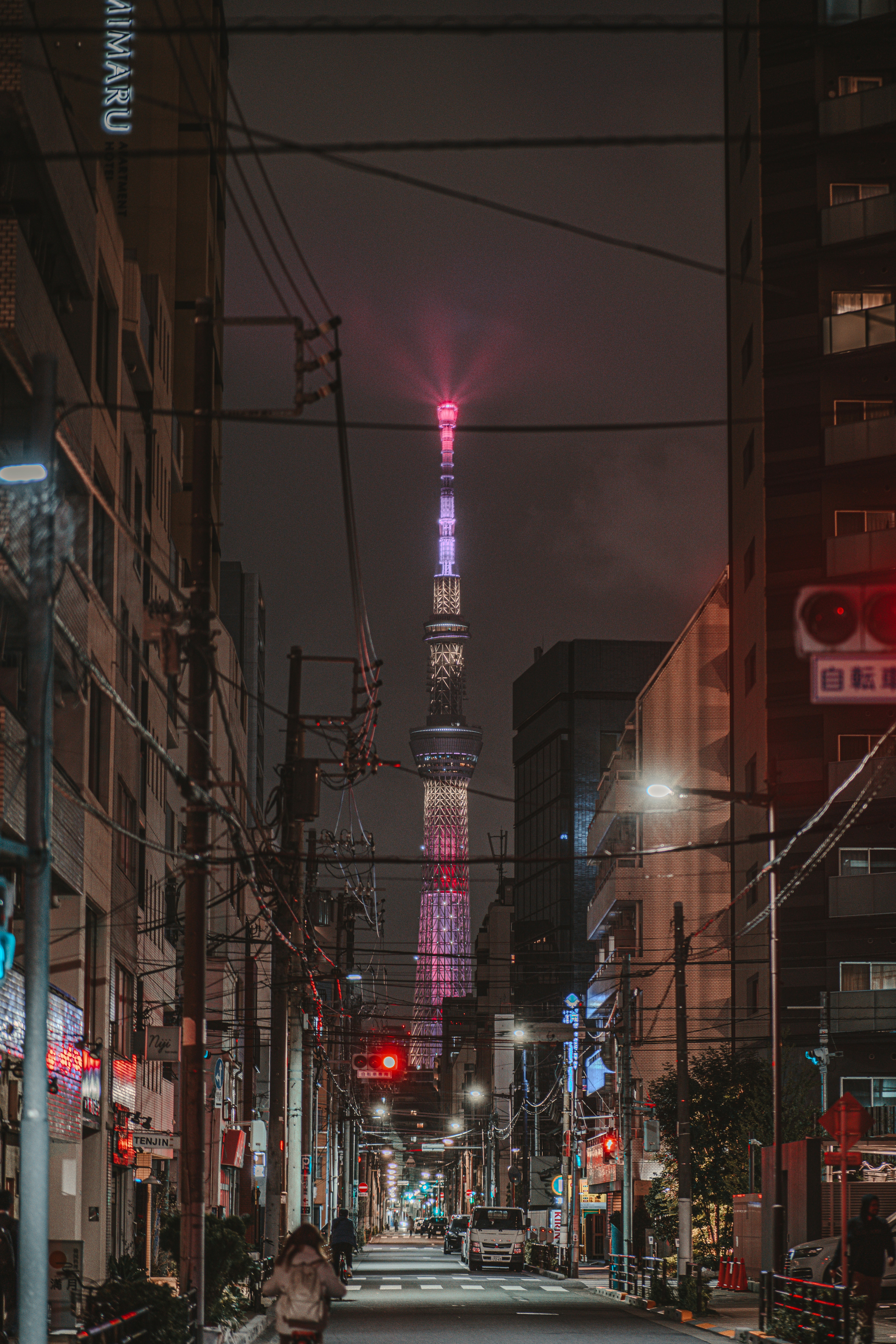 A city street at night with a tall building in the backgroundMatt Mutlu